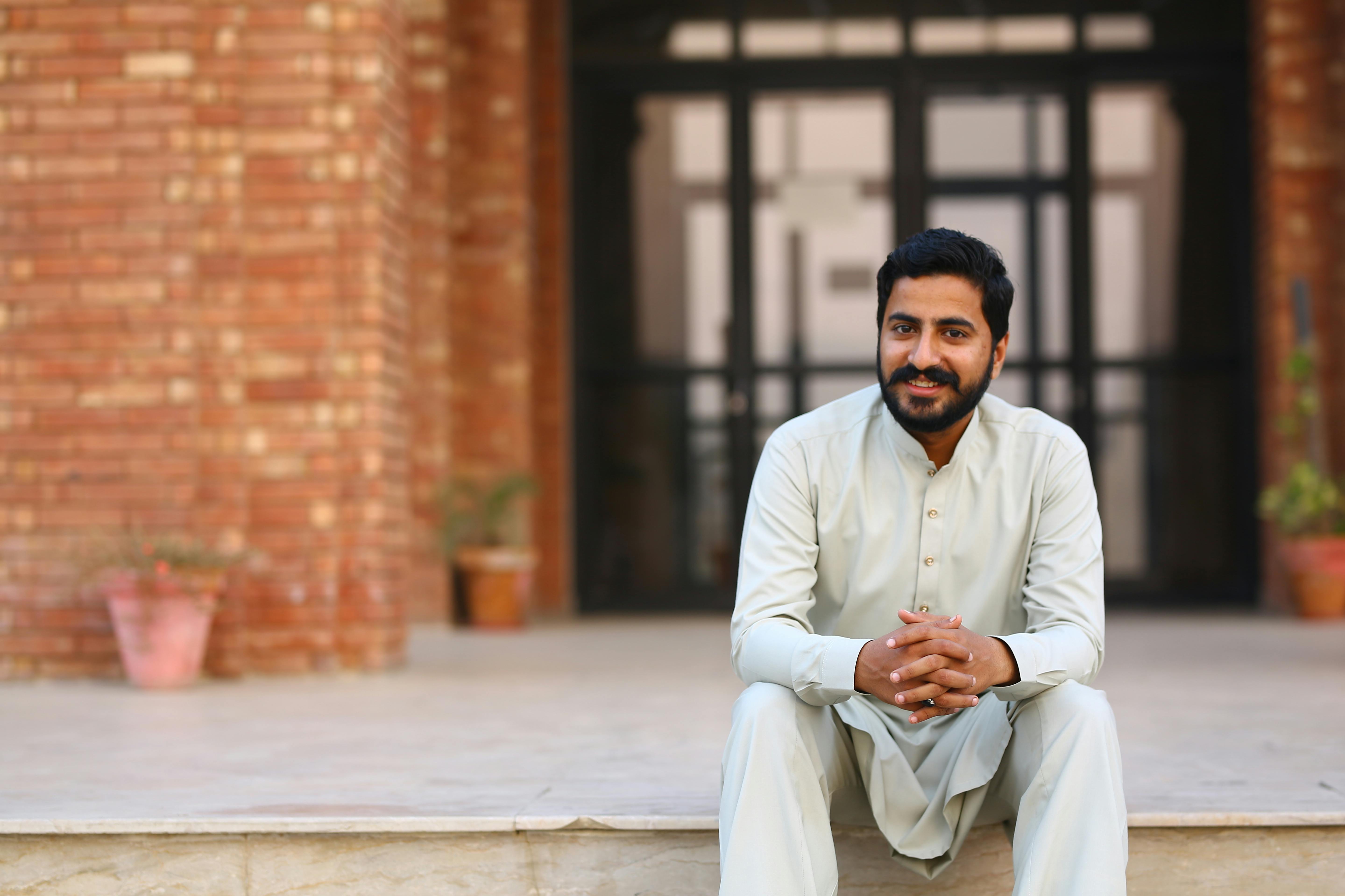 Smiling Man Sitting on Step · Free Stock Photo