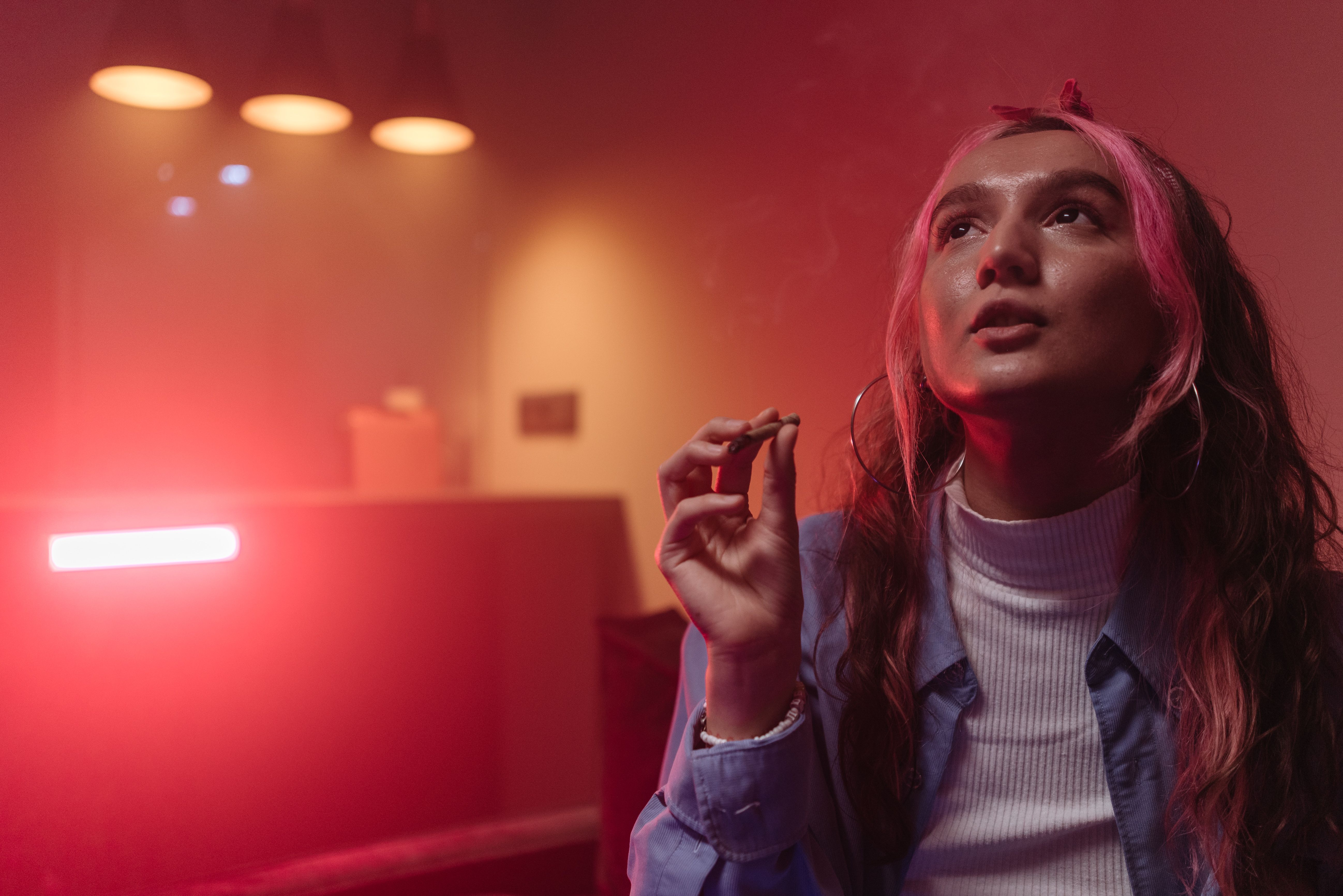 A Woman Looking Up While Smoking · Free Stock Photo