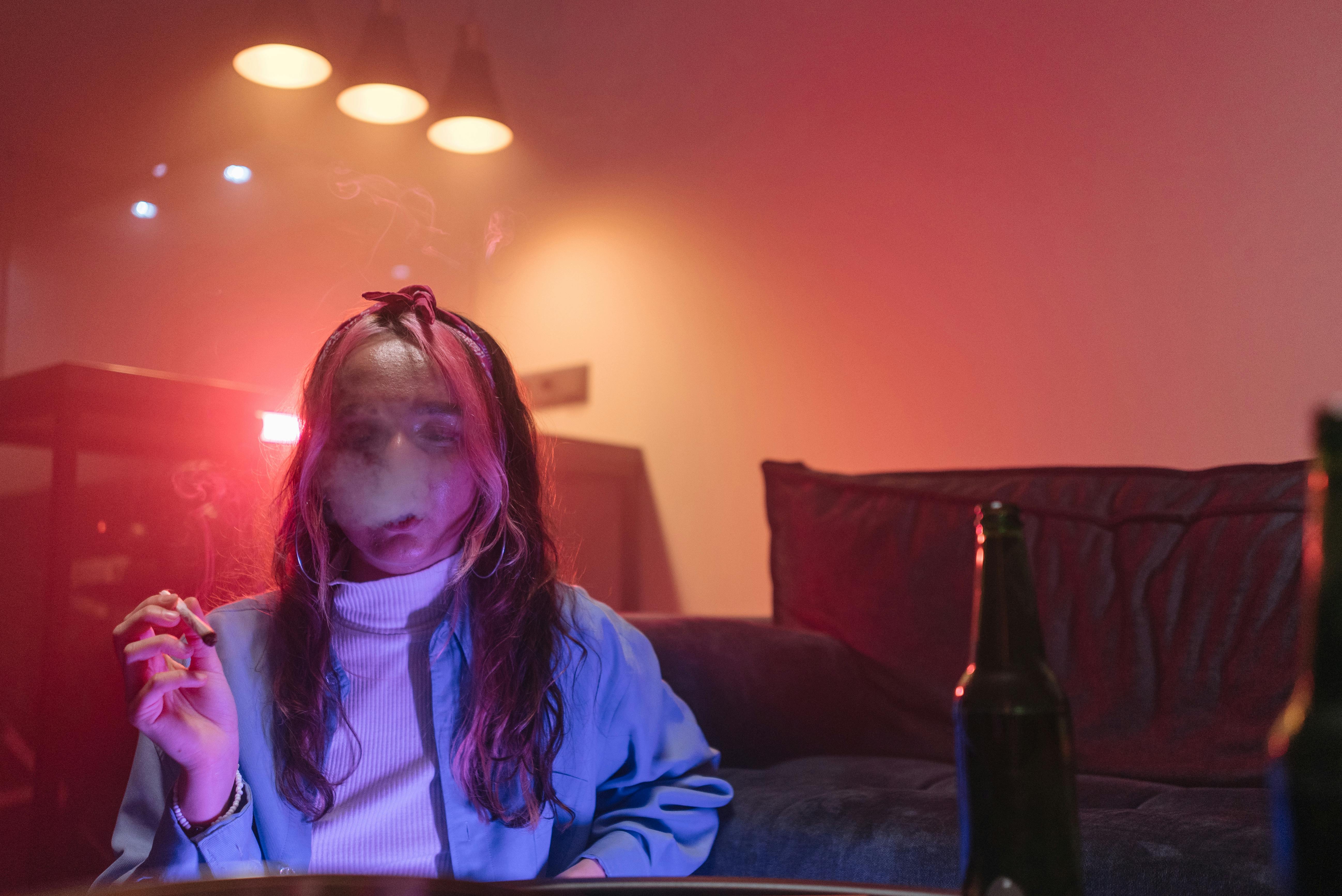 Woman Smoking Alone Near the Couch · Free Stock Photo