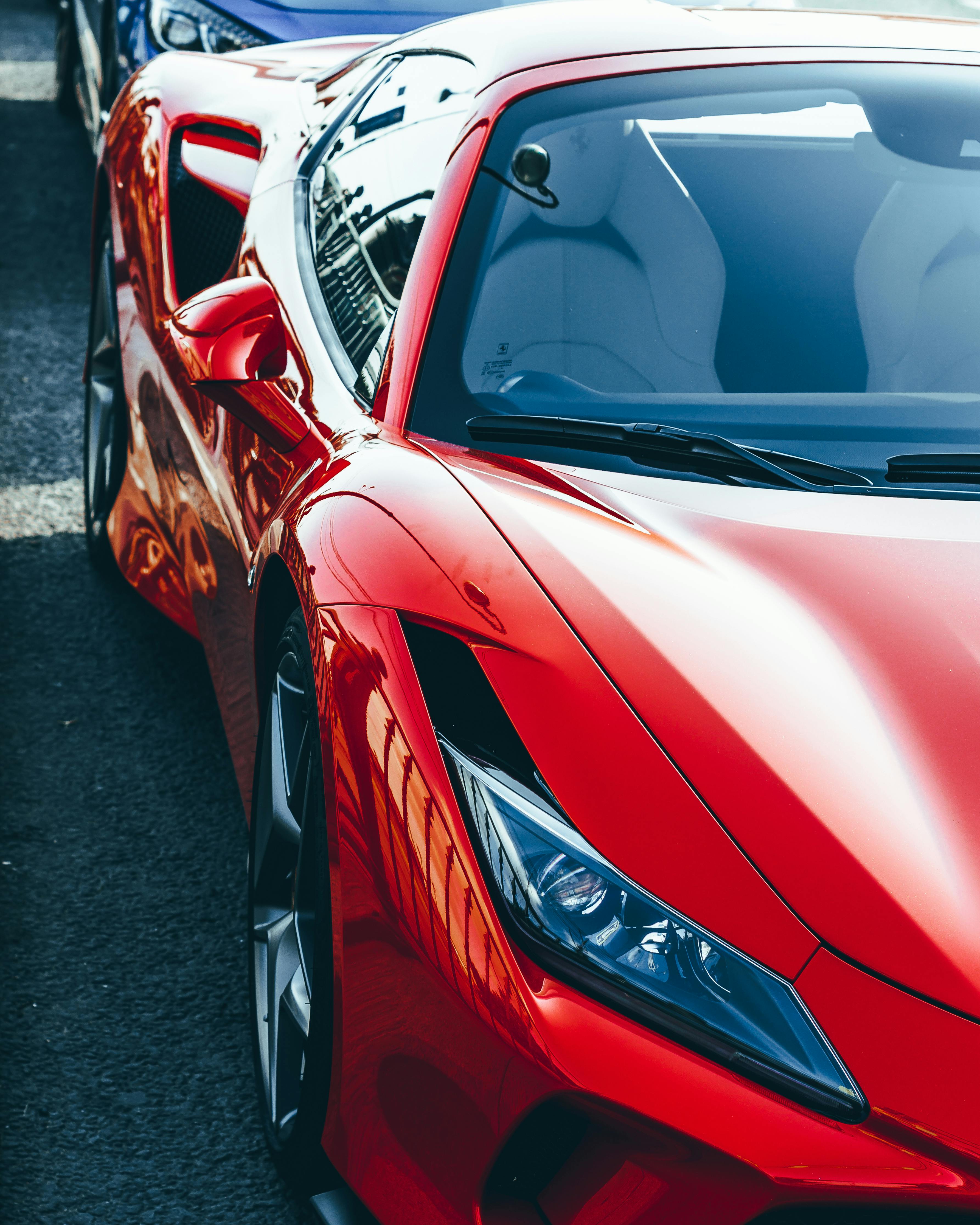 Close-Up Shot of a Red Sports Car Parked on the Road · Free Stock Photo