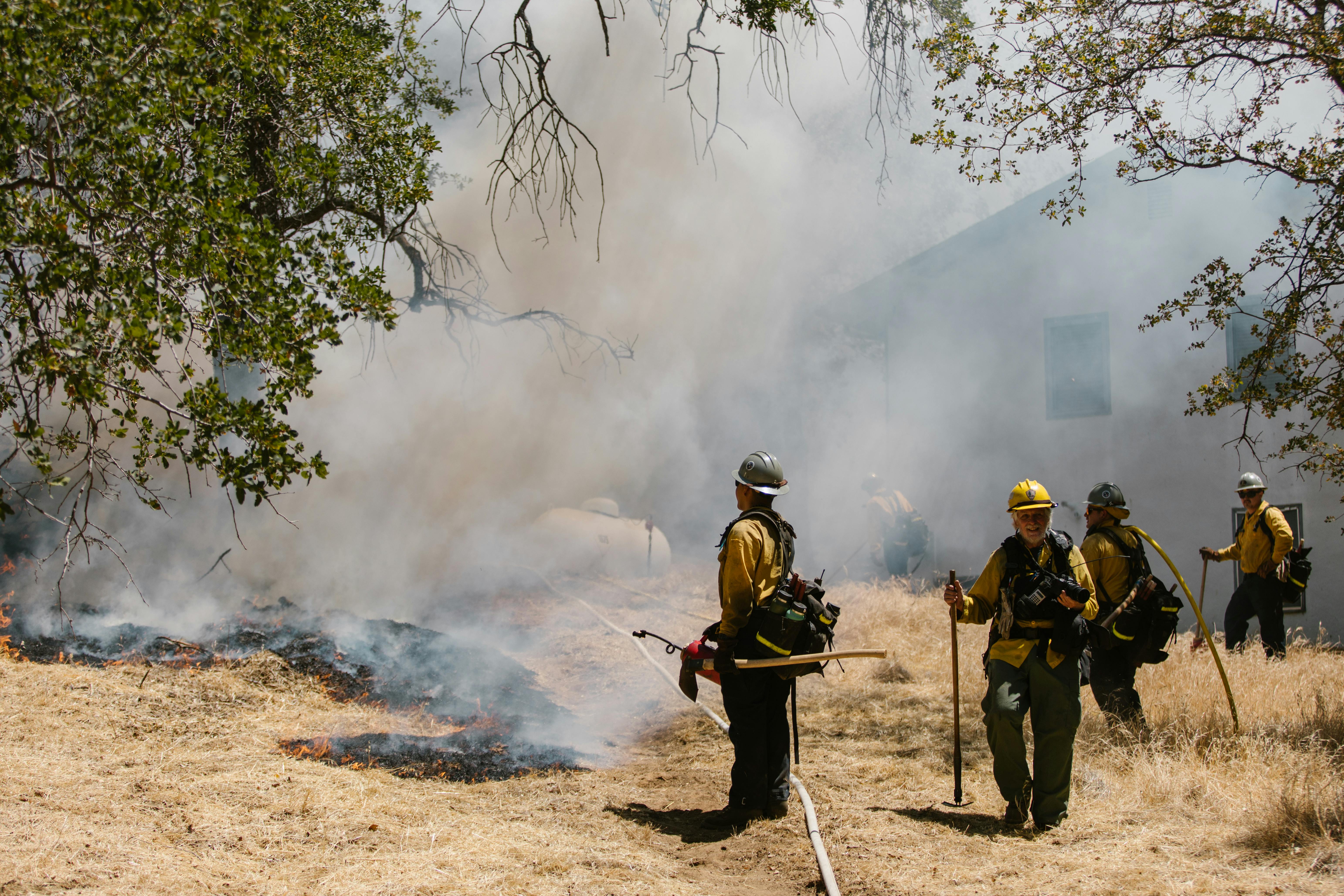 A Firefighters Stopping a Grass Fire · Free Stock Photo