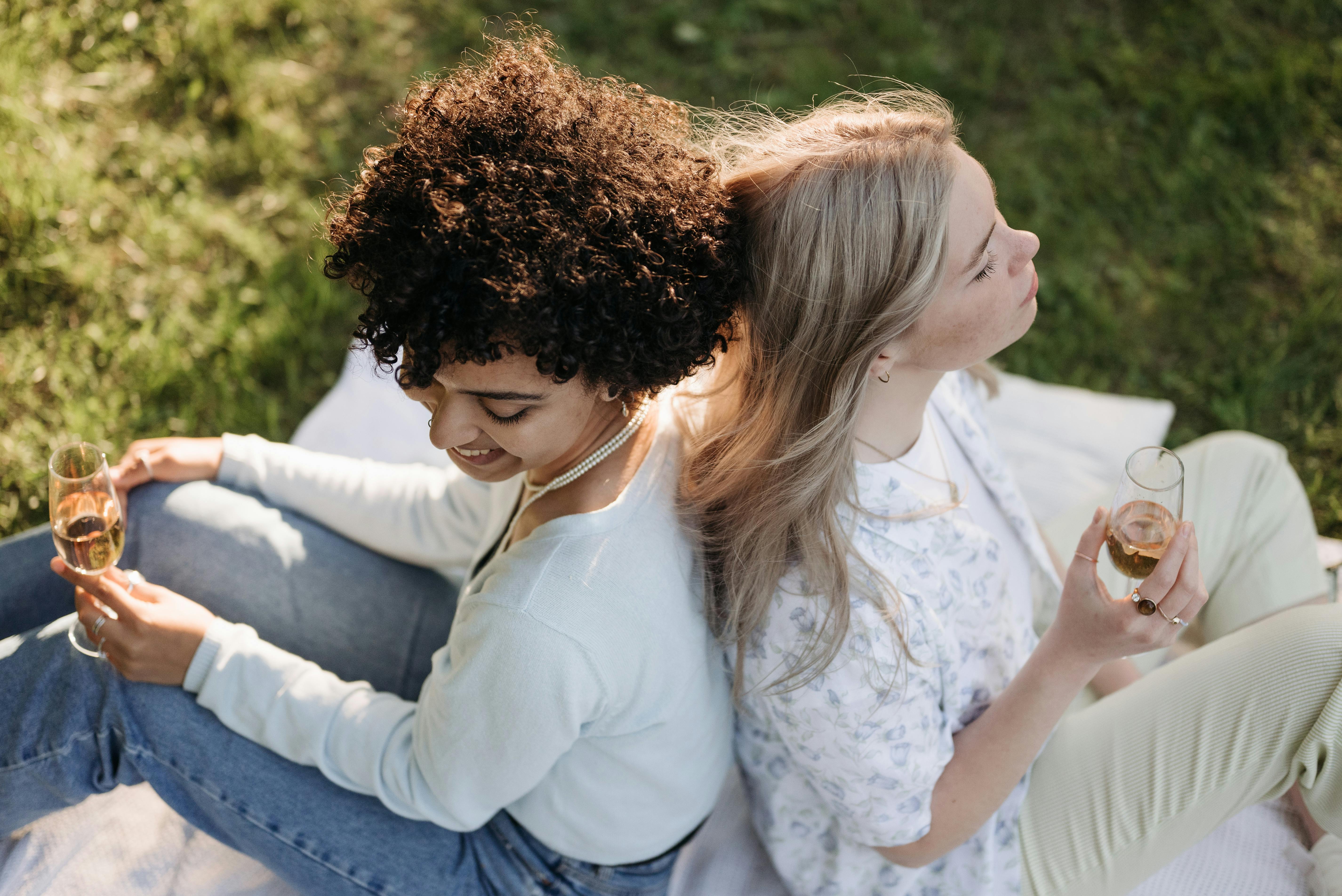 A Couple Sitting Back to Back · Free Stock Photo