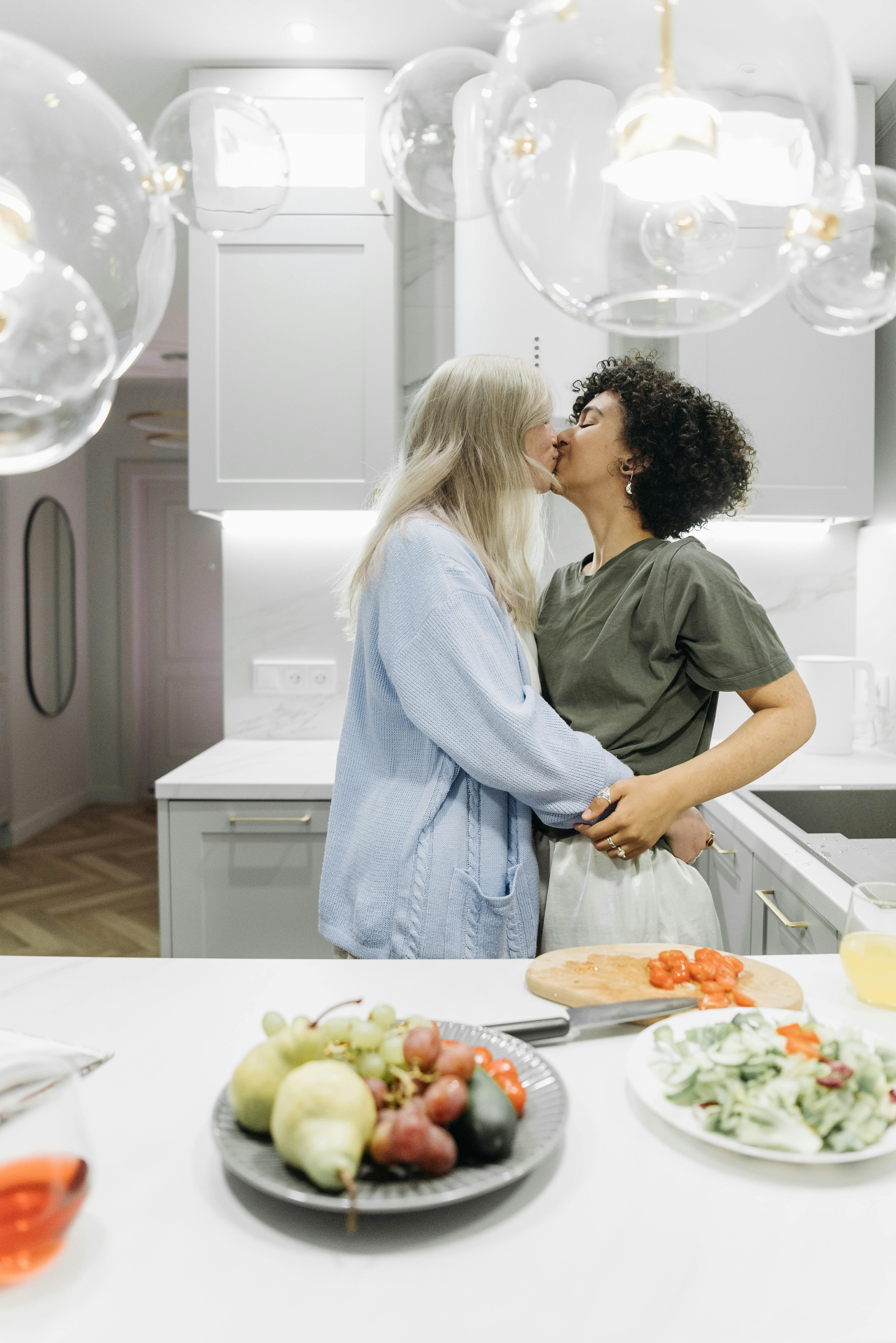 Couple Kissing while in the Kitchen · Free Stock Photo
