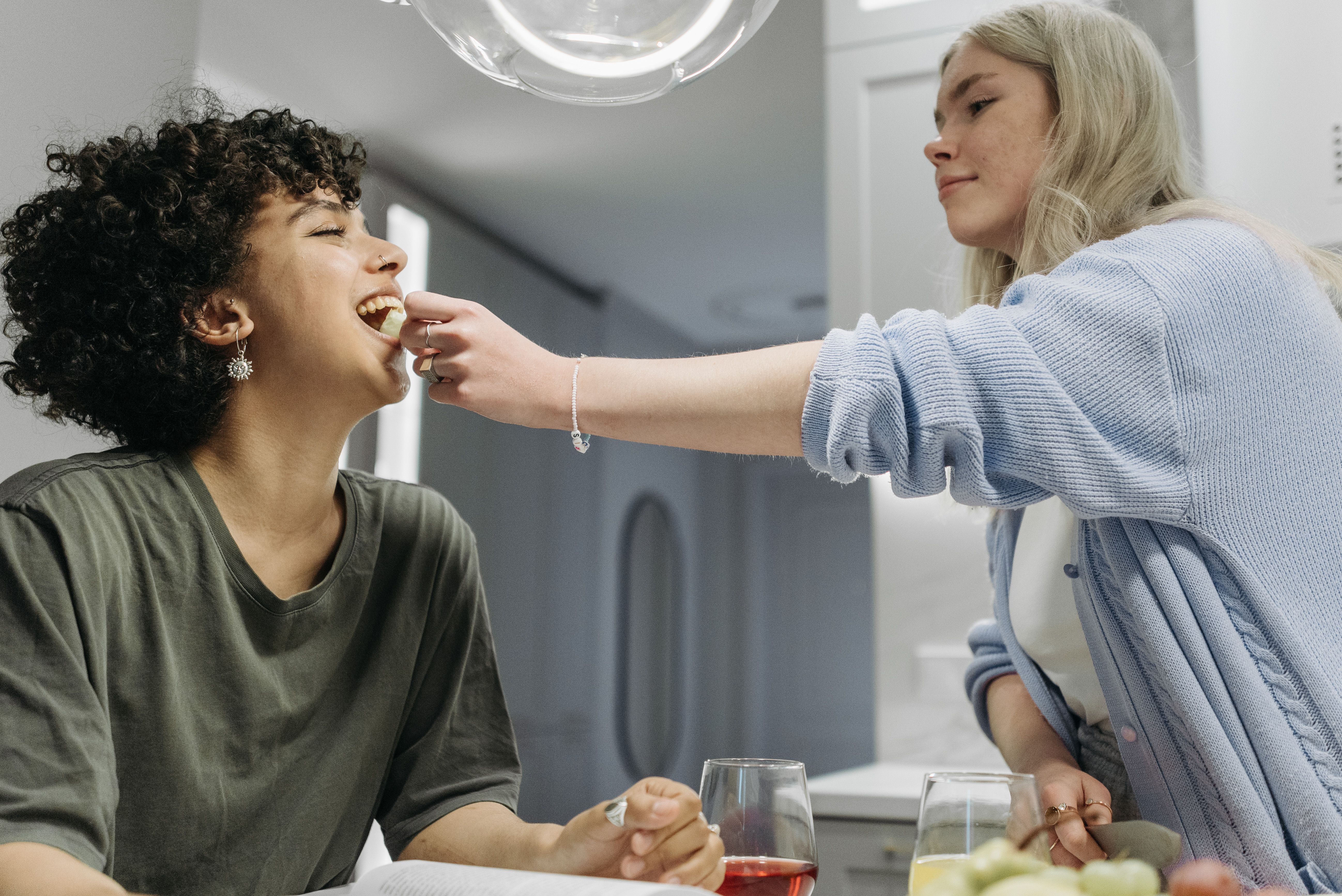 Woman Feeding her Friend · Free Stock Photo