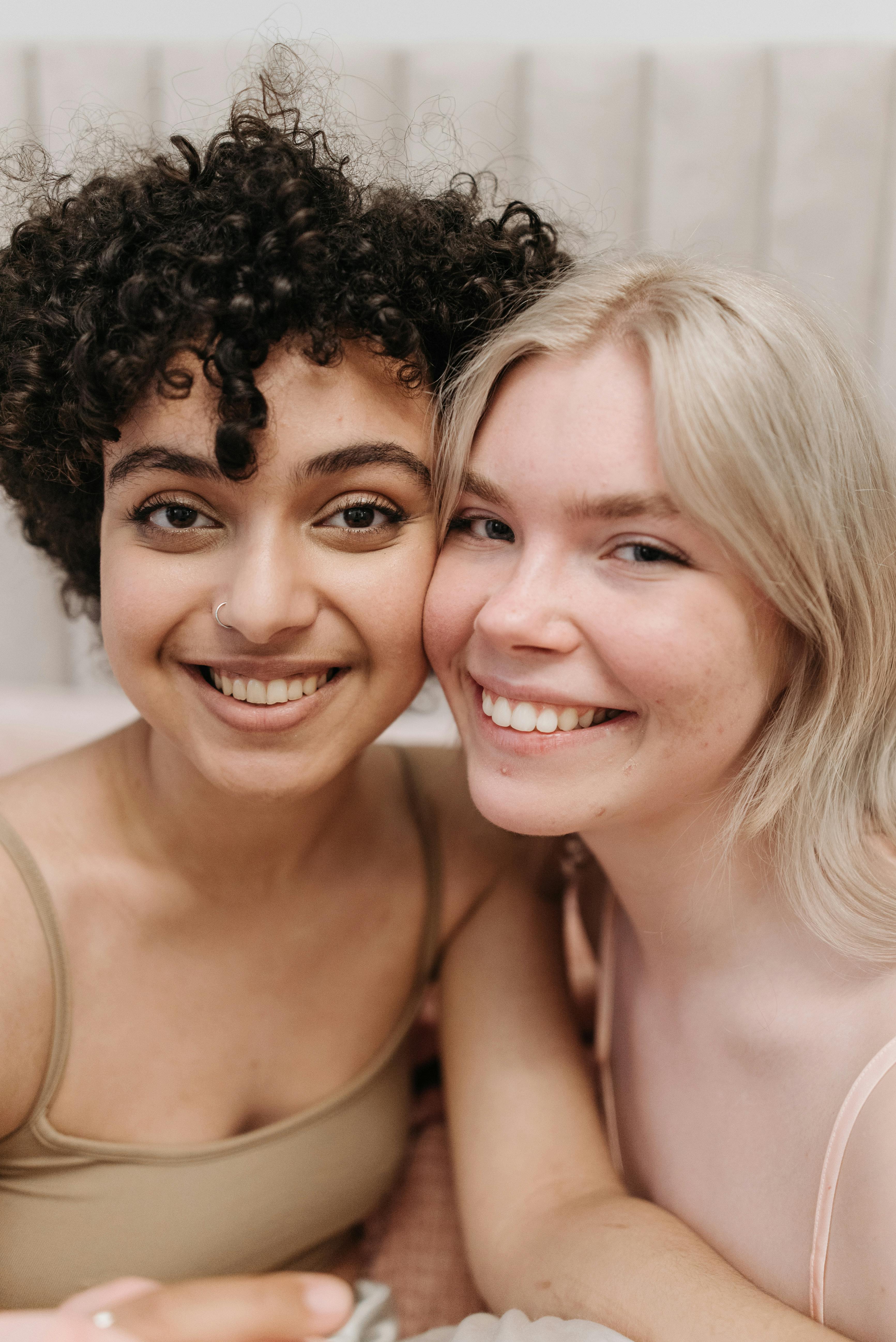 Two Women Smiling Together · Free Stock Photo