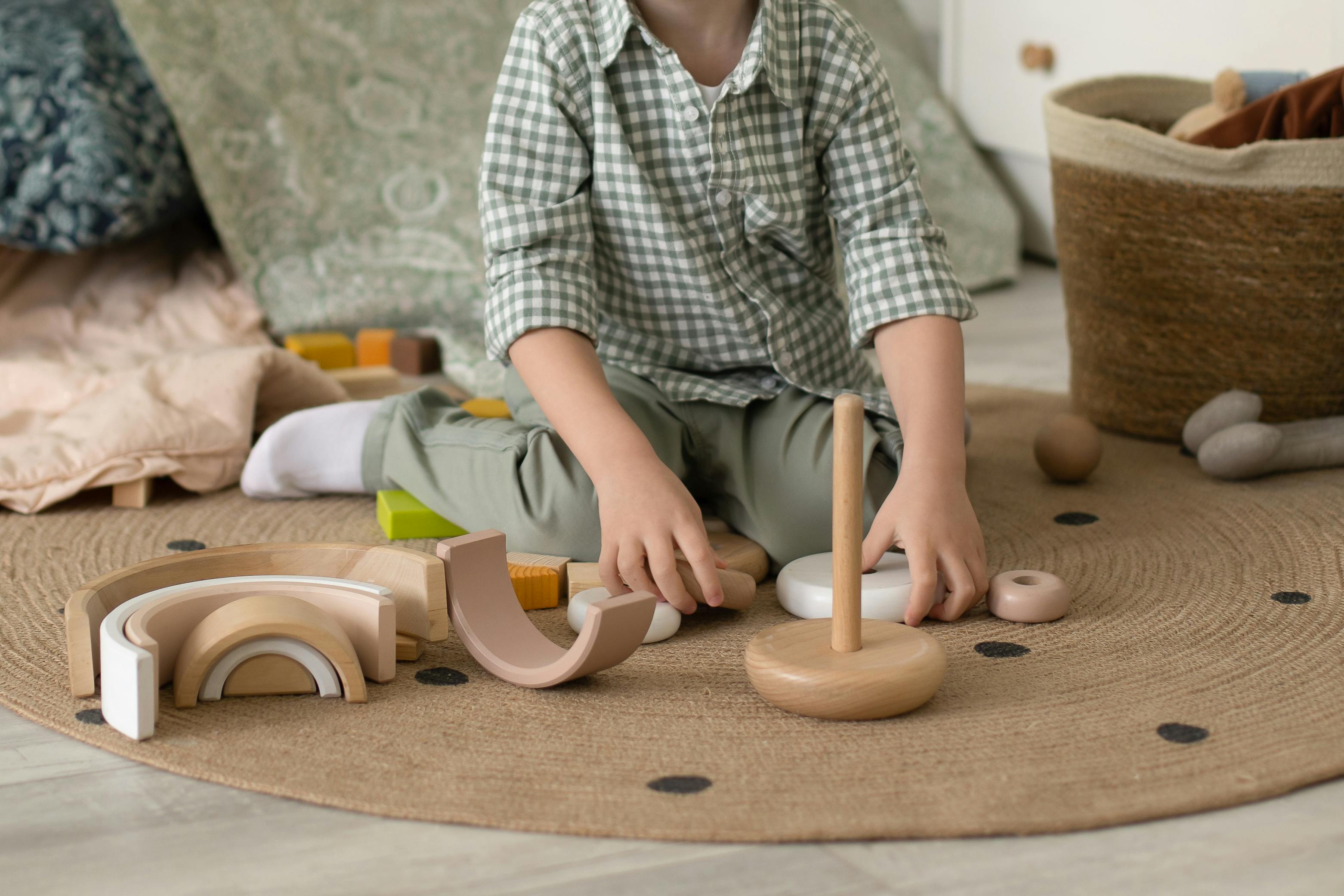 Child Sitting on a Rug in a Bedroom · Free Stock Photo