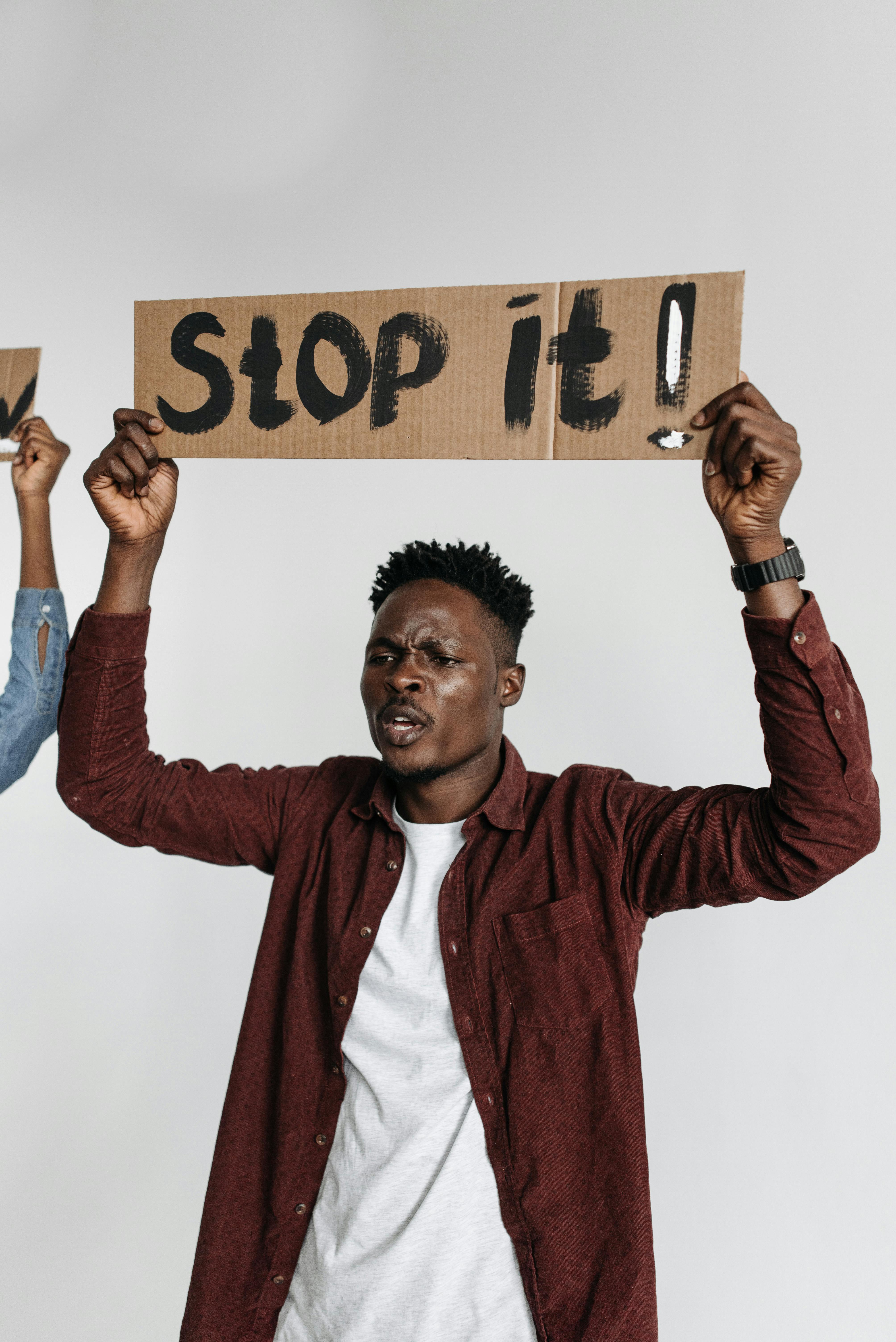 Man Holding Stop It Sign · Free Stock Photo