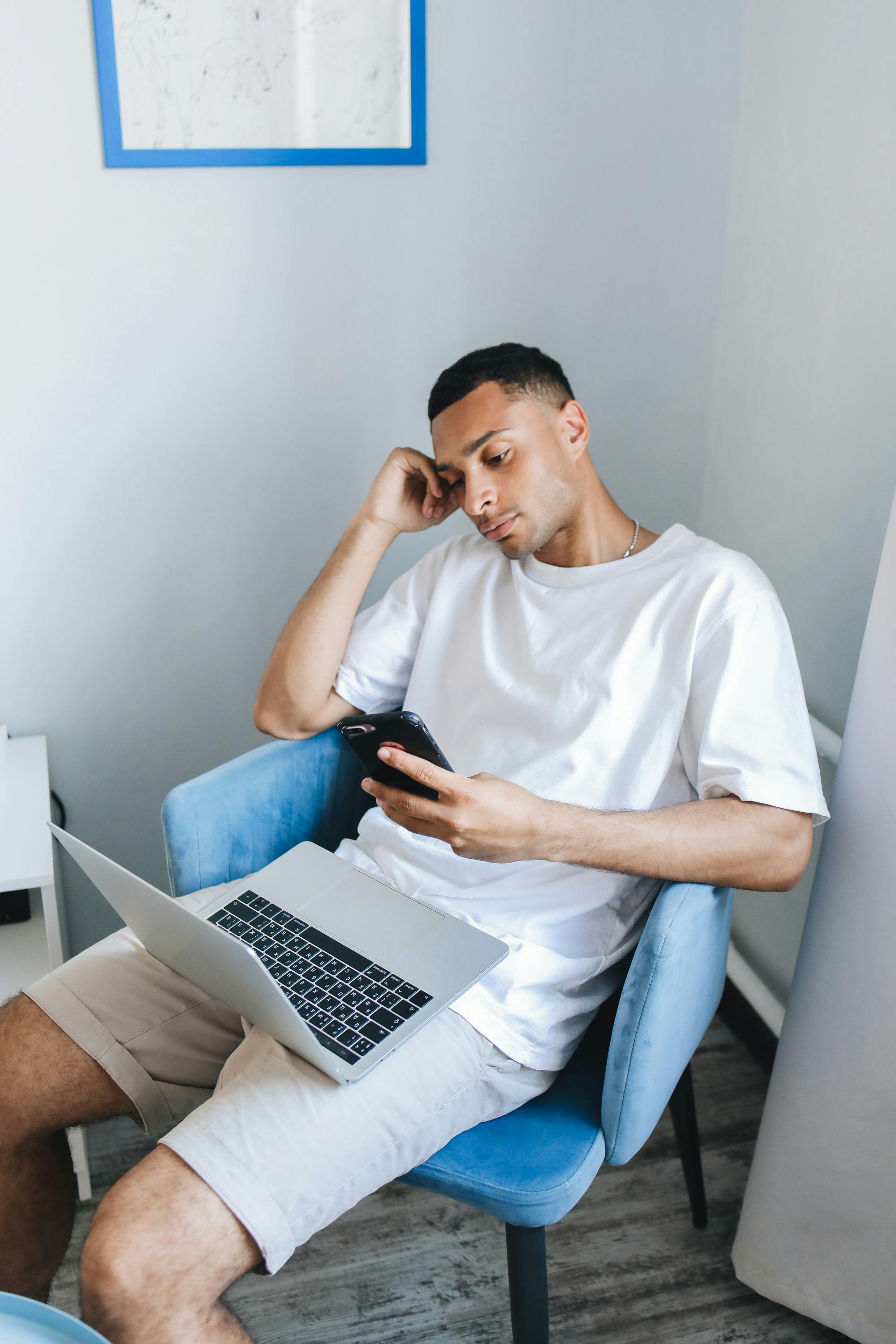 Bored Man Browsing His Smartphone · Free Stock Photo