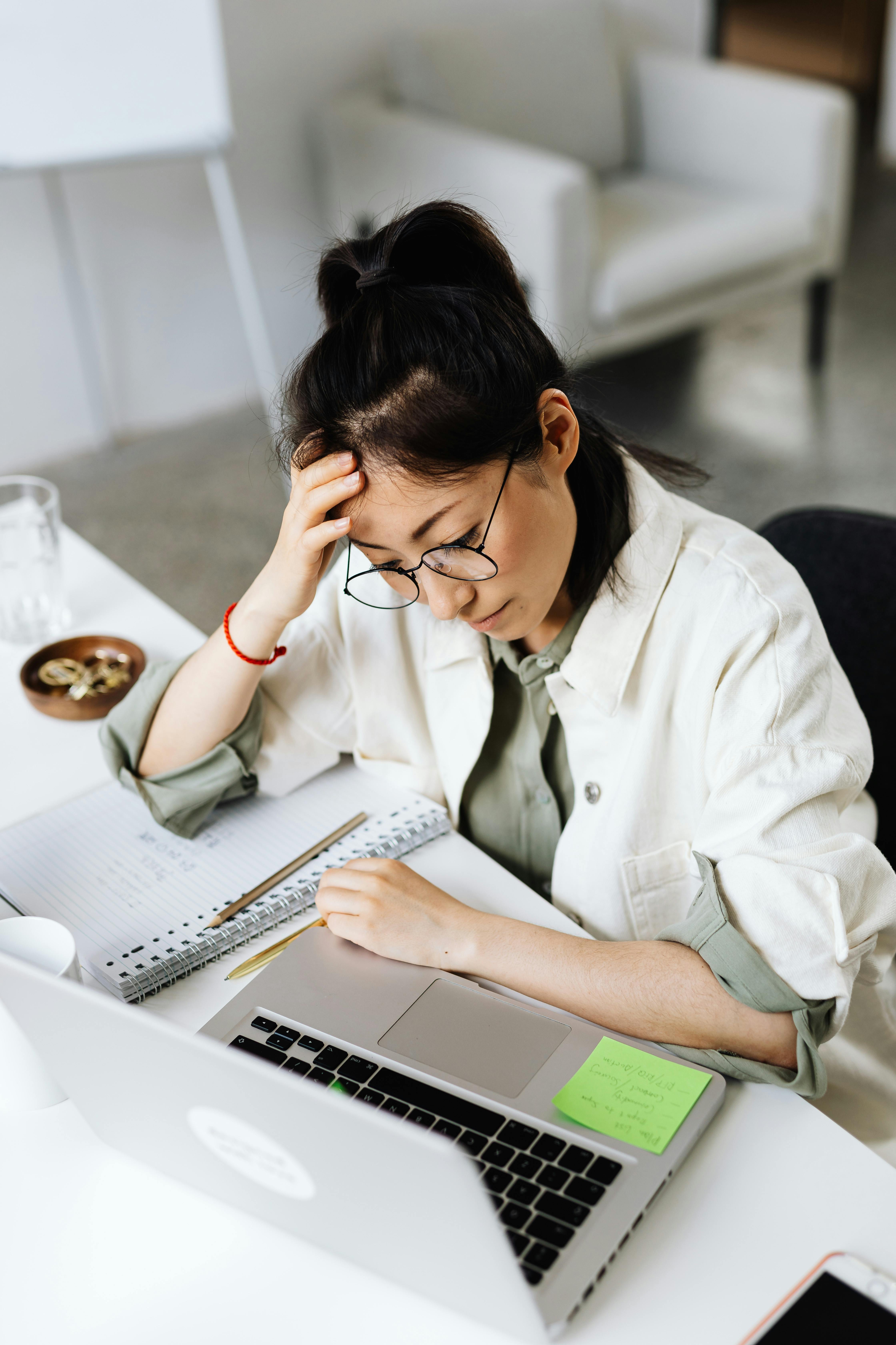 Overworked Employee lying in front of Laptop · Free Stock Photo