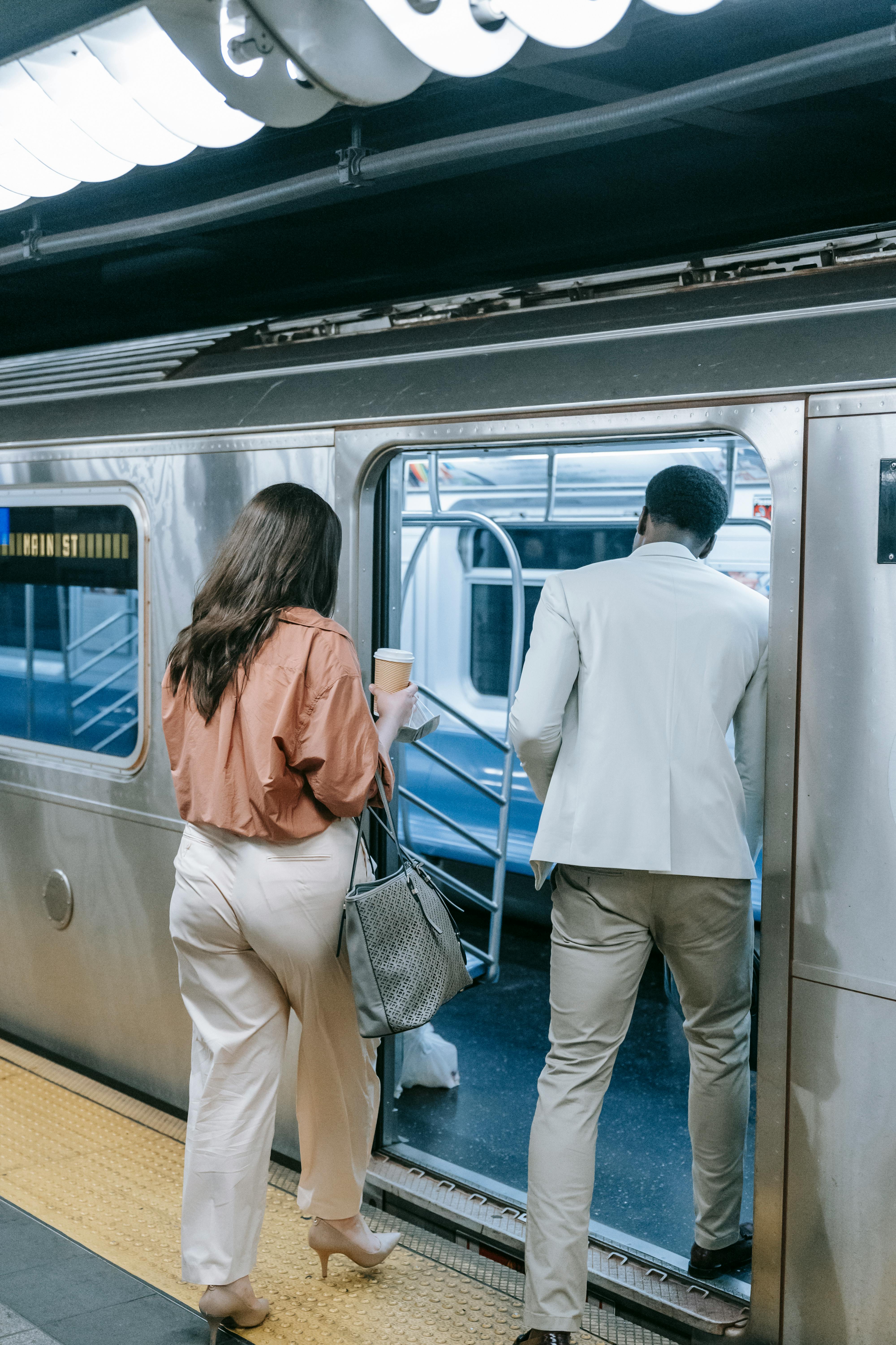 Man and Woman Entering a Train · Free Stock Photo