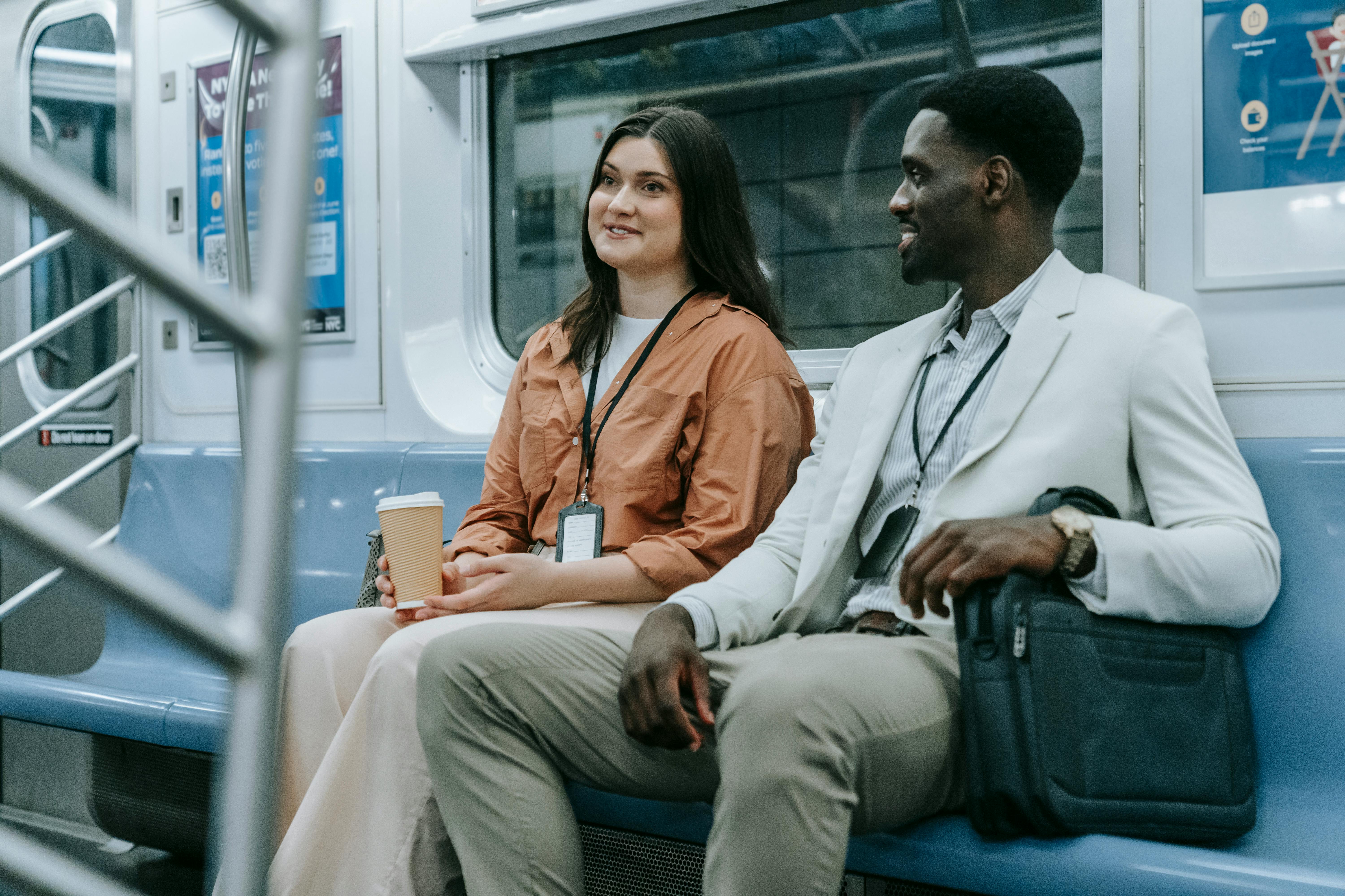 A Man and Woman Sitting Inside the Train while Having Conversation ...