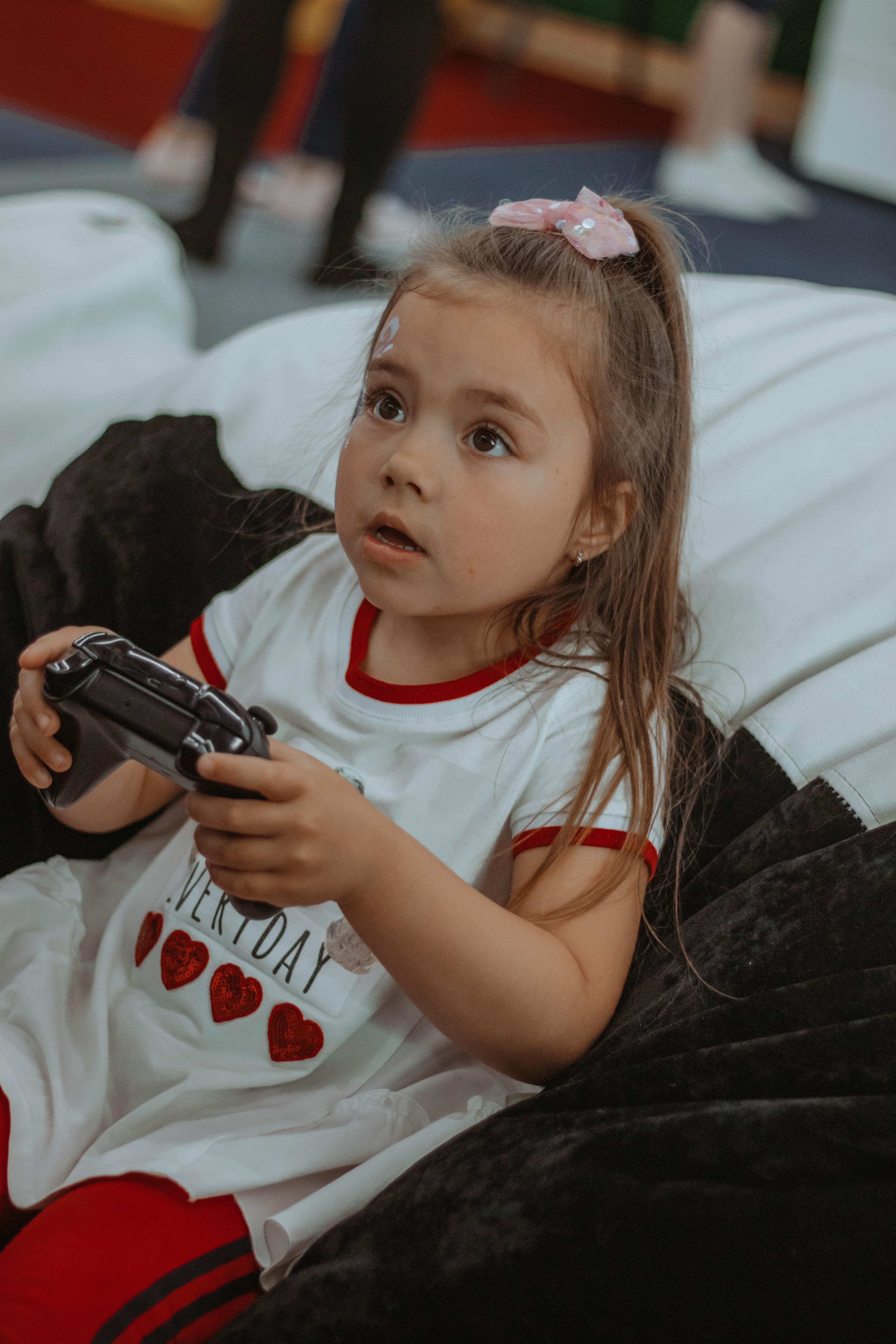 Girl Playing with Controller · Free Stock Photo