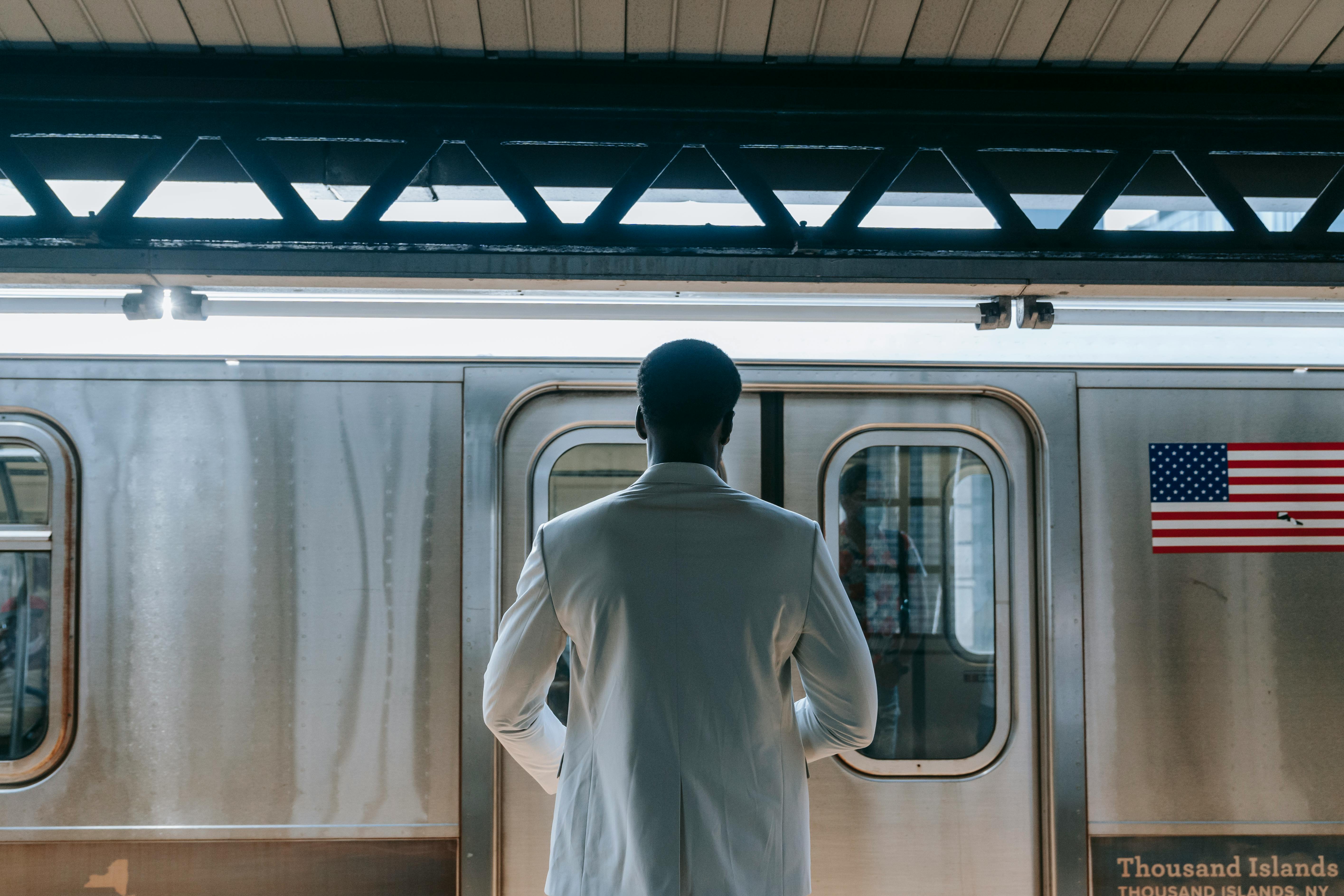 Man in Suit Jacket Standing in Front of Train · Free Stock Photo