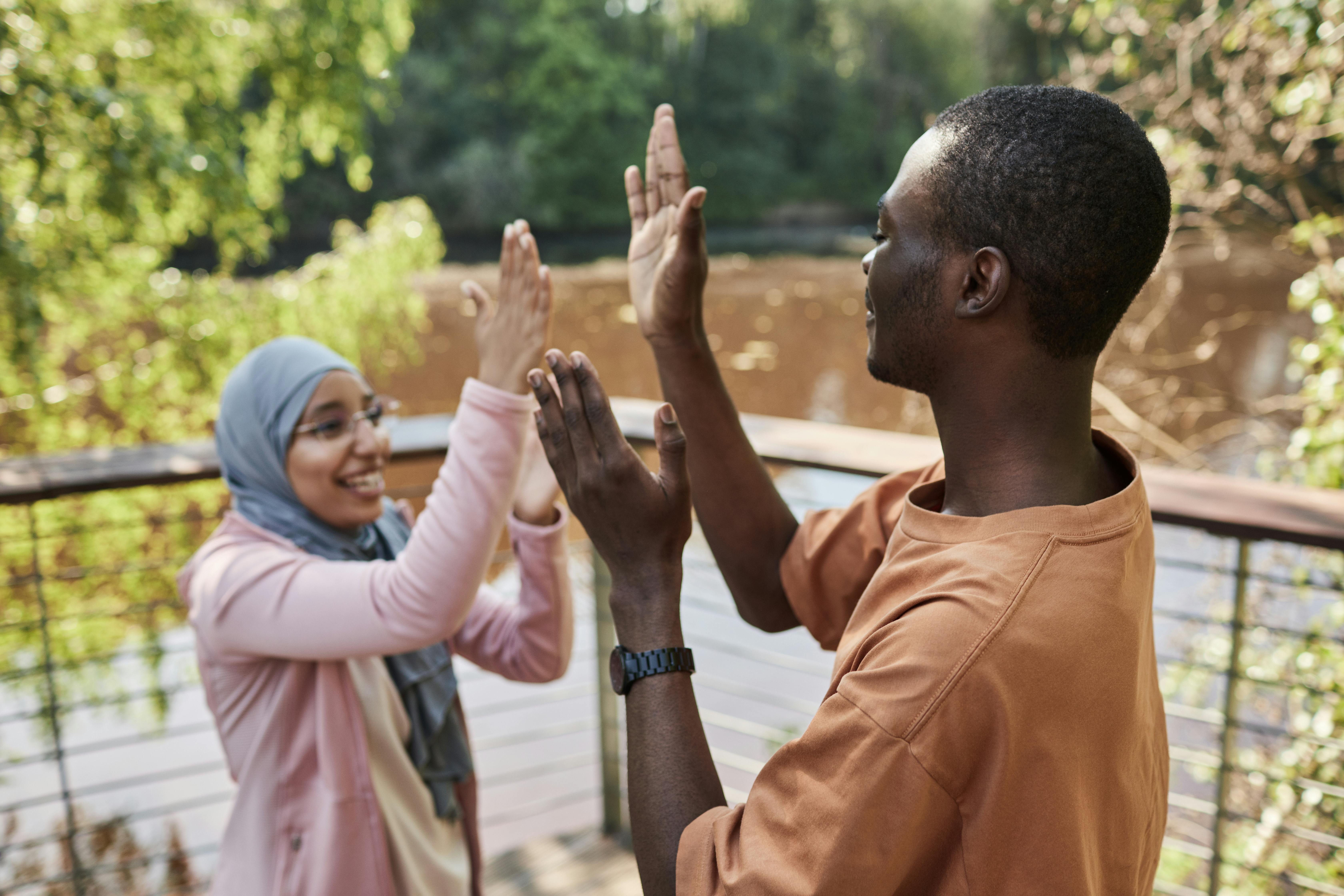 Man and Woman Doing High Five · Free Stock Photo