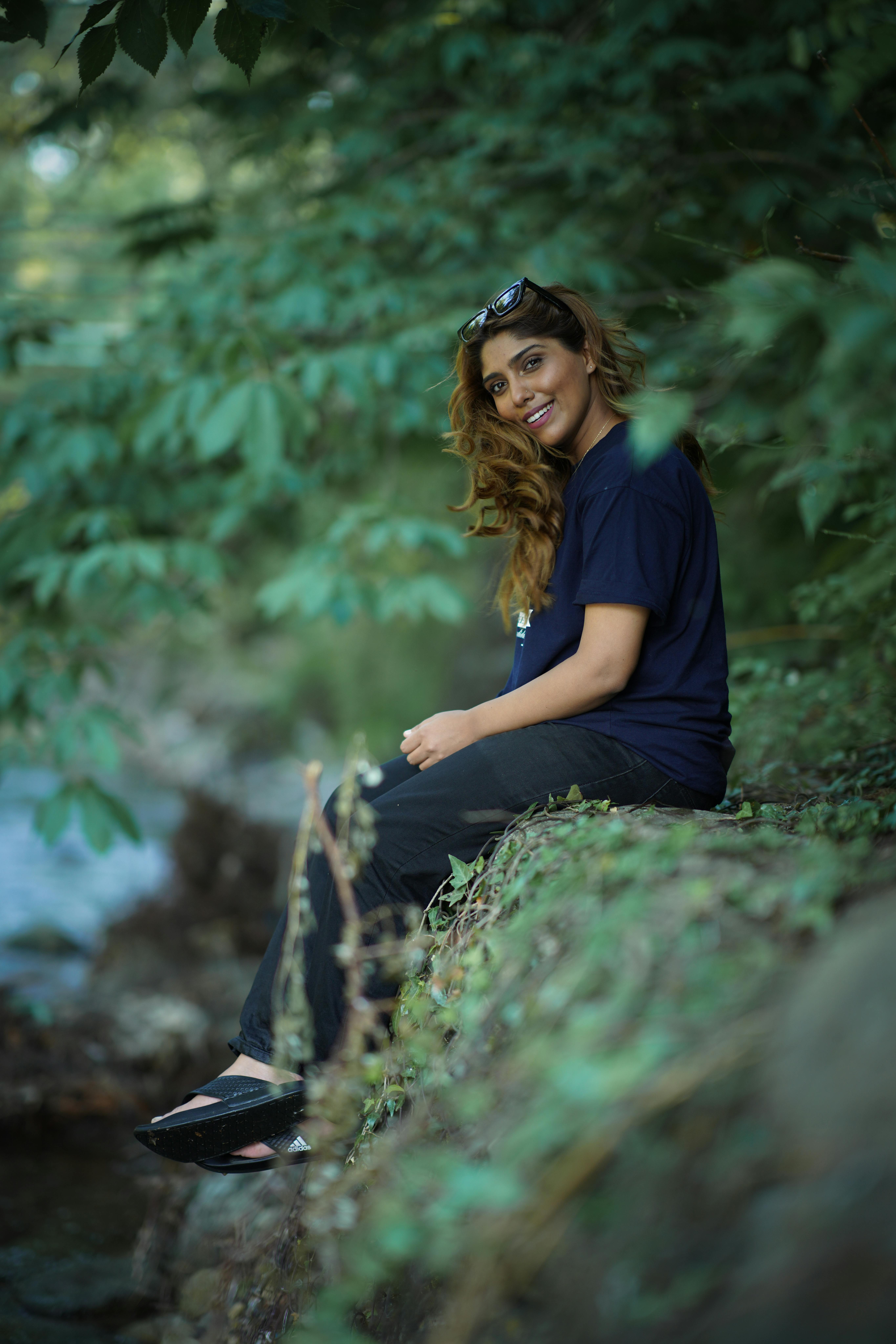 Woman Sitting Near Tree Smiling · Free Stock Photo