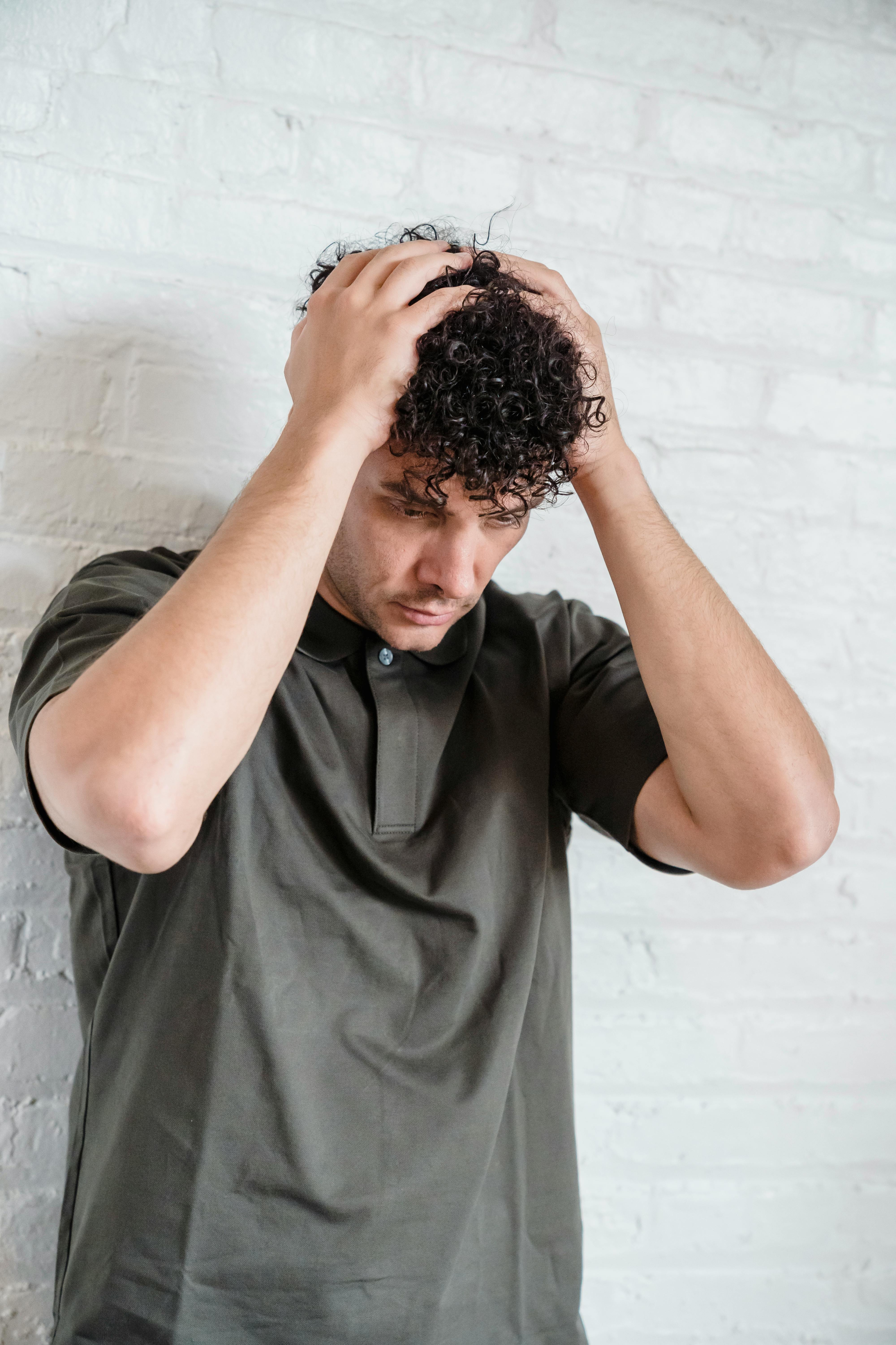 Photo Of A Man Touching His Head · Free Stock Photo