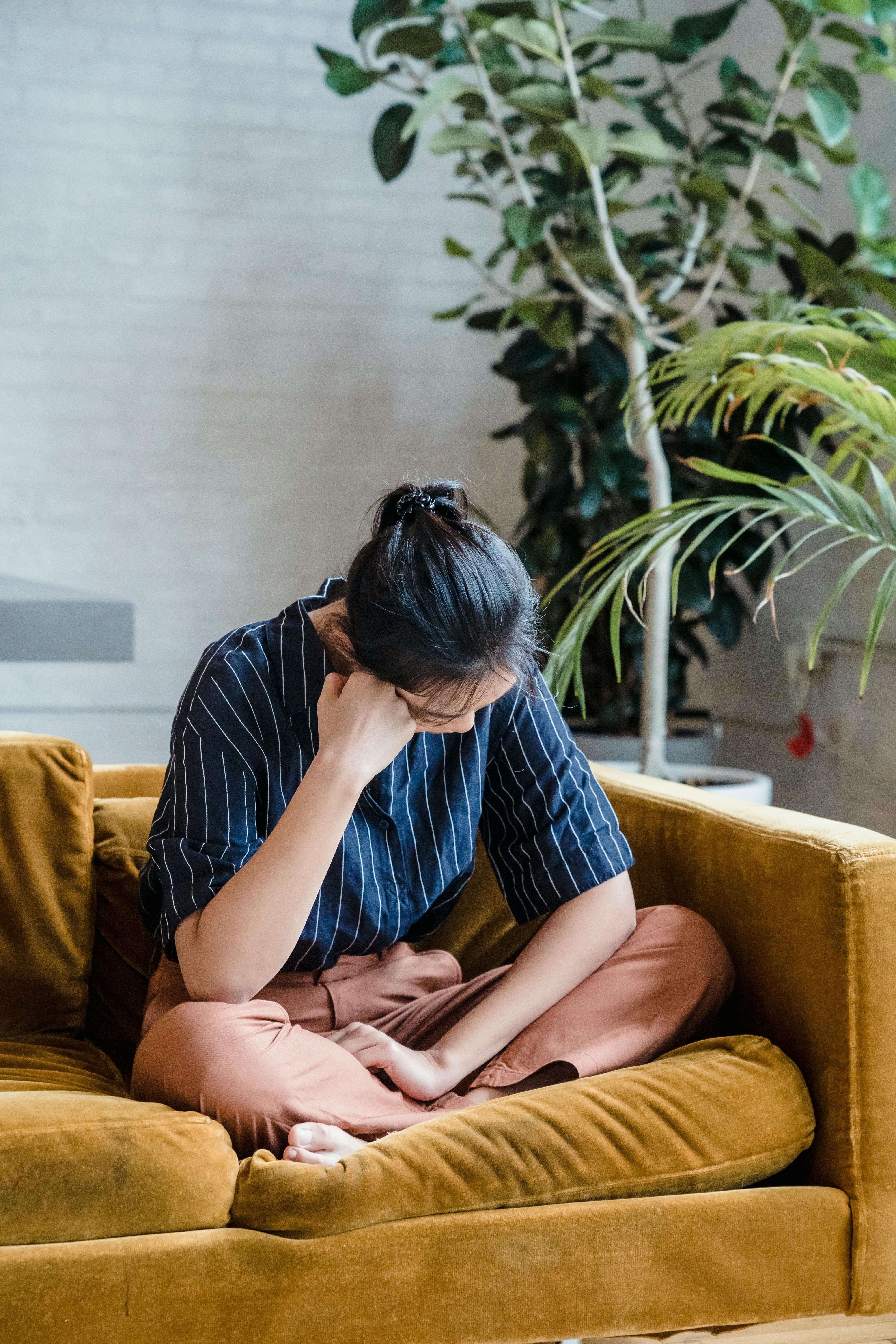 Sad Person Sitting Alone on a Couch · Free Stock Photo