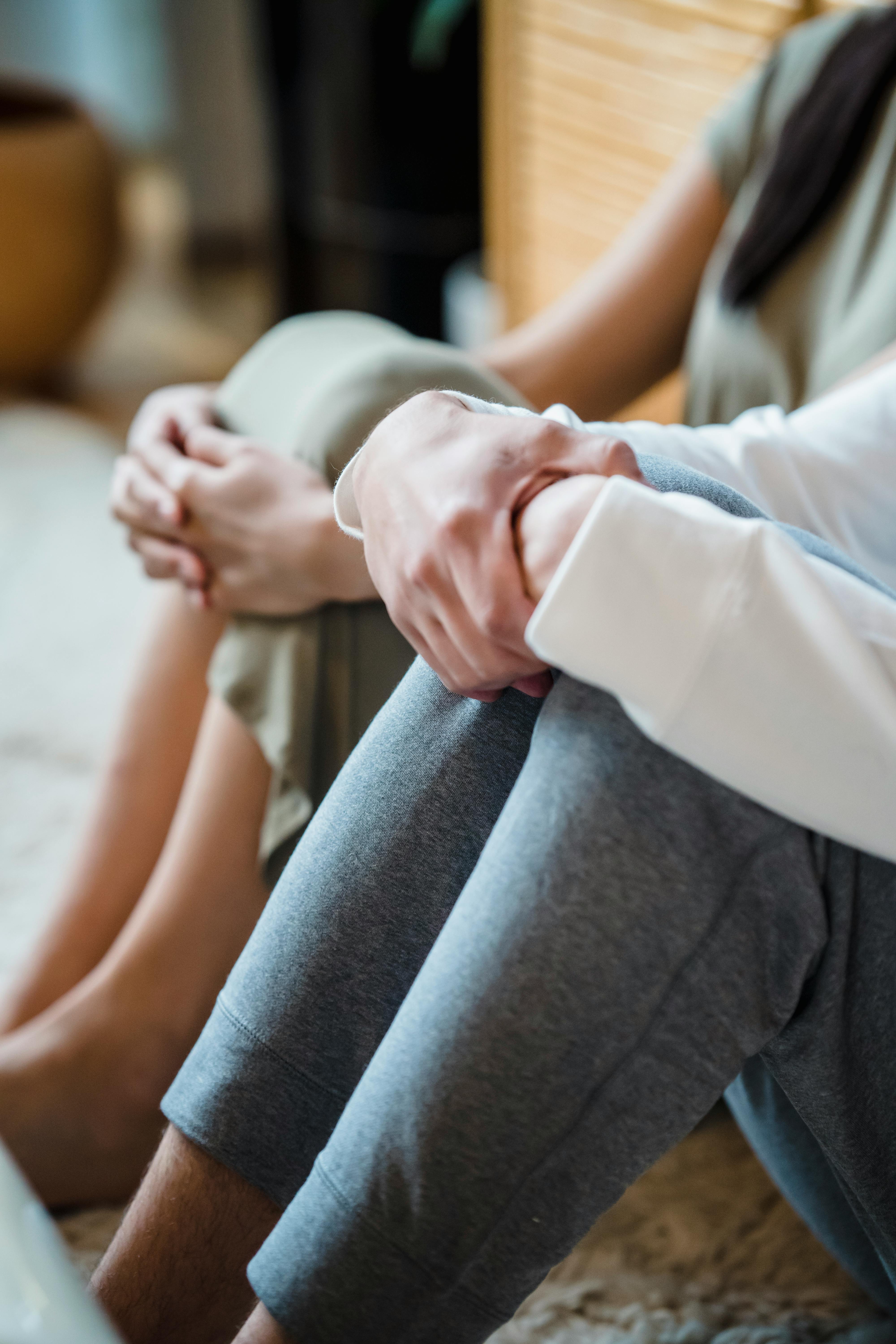 Legs of Two People Sitting Side by Side on the Floor · Free Stock Photo