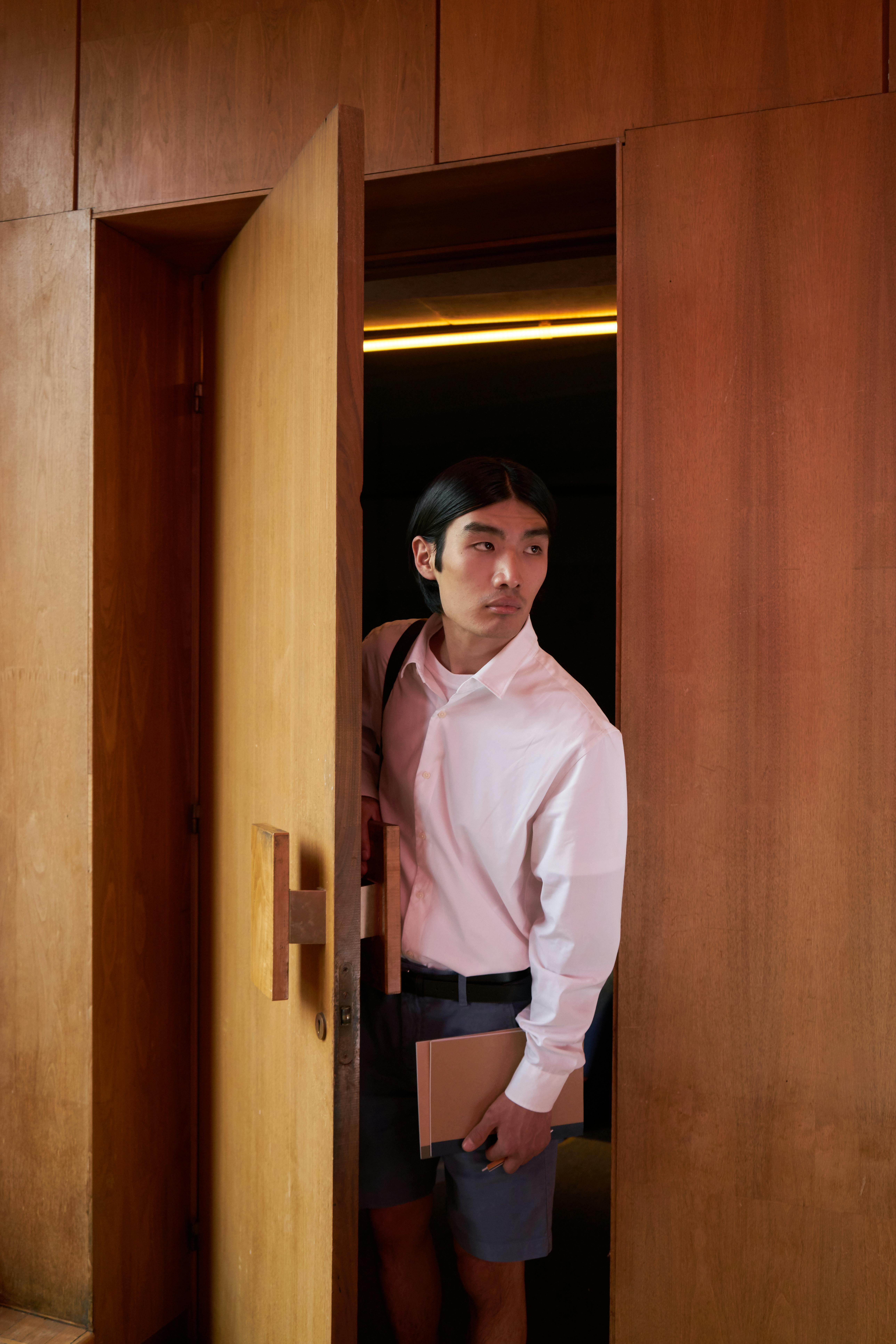 Man Standing by the Door · Free Stock Photo