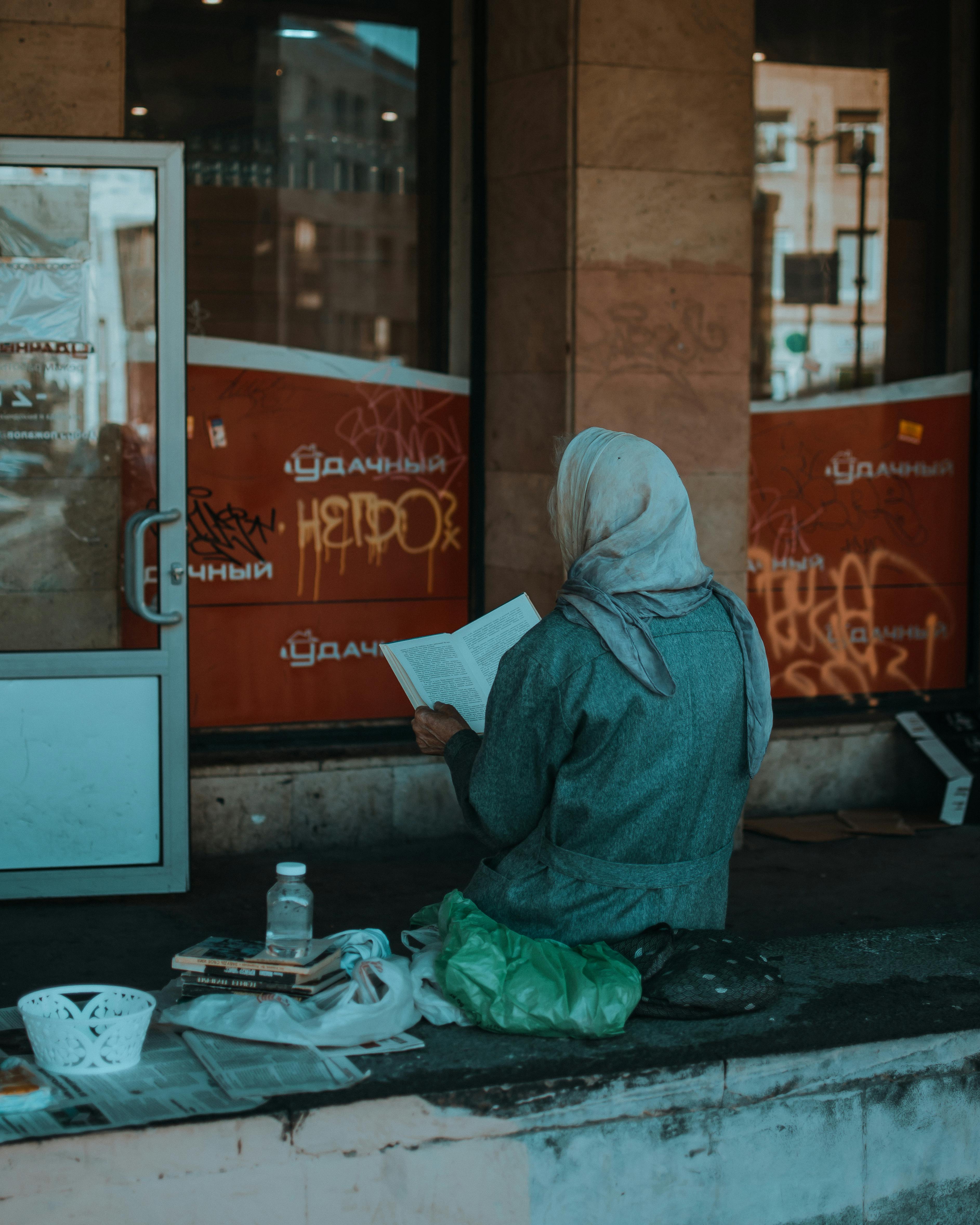 Back View of Woman Sitting Reading a Book · Free Stock Photo