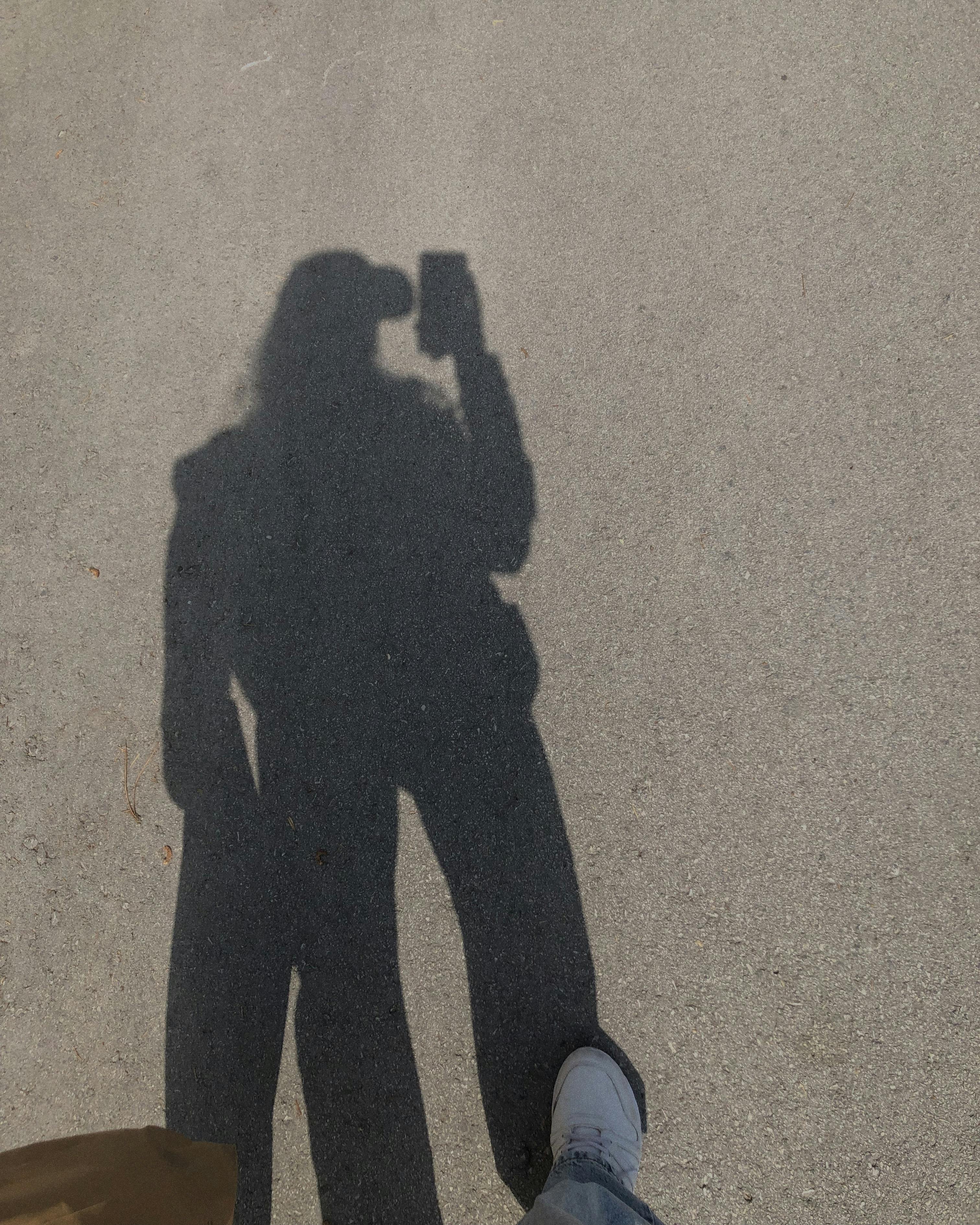 Shadow of a Person Using Smartphone · Free Stock Photo
