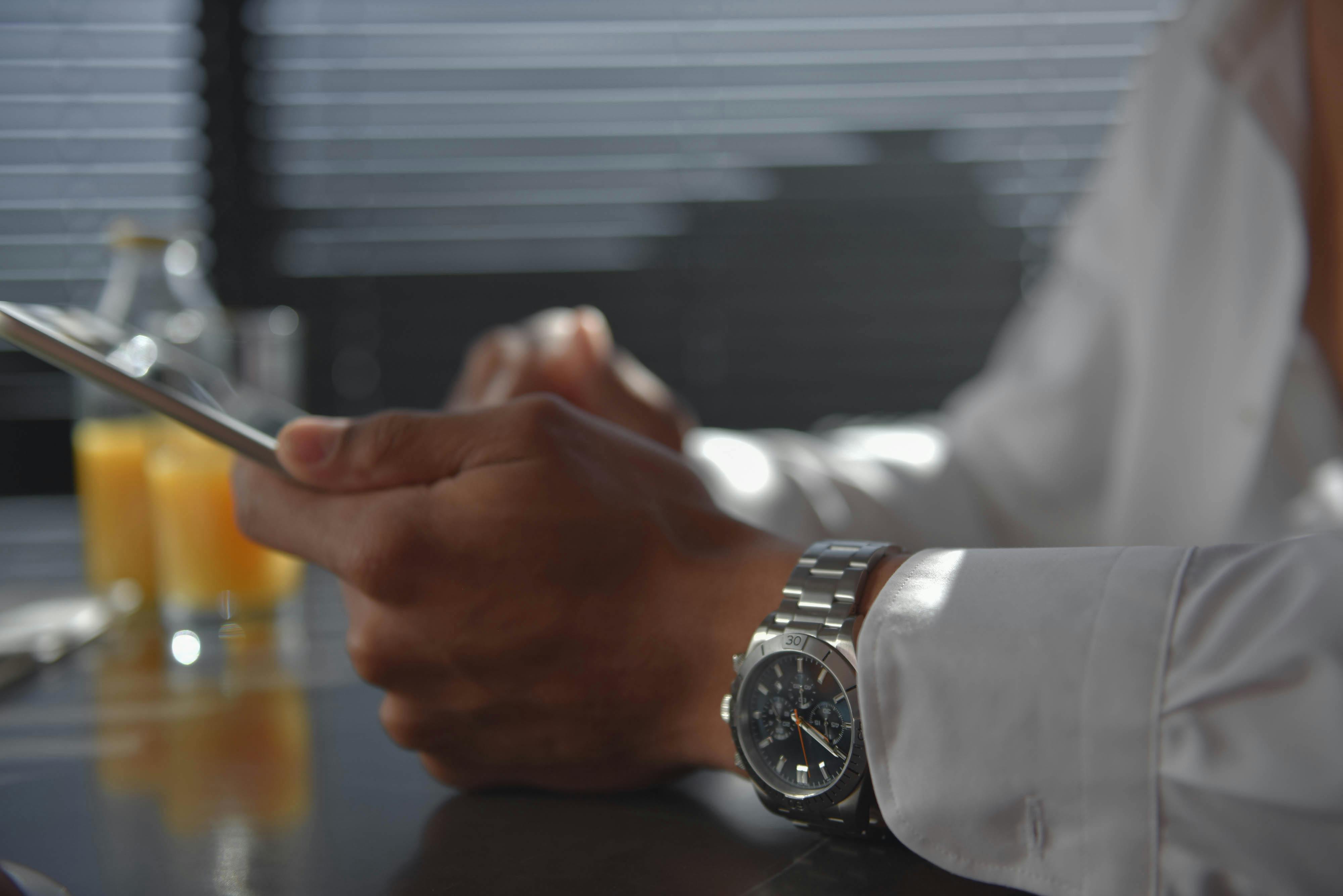Close-Up Photo of a Person Wearing a Silver Wristwatch · Free Stock Photo