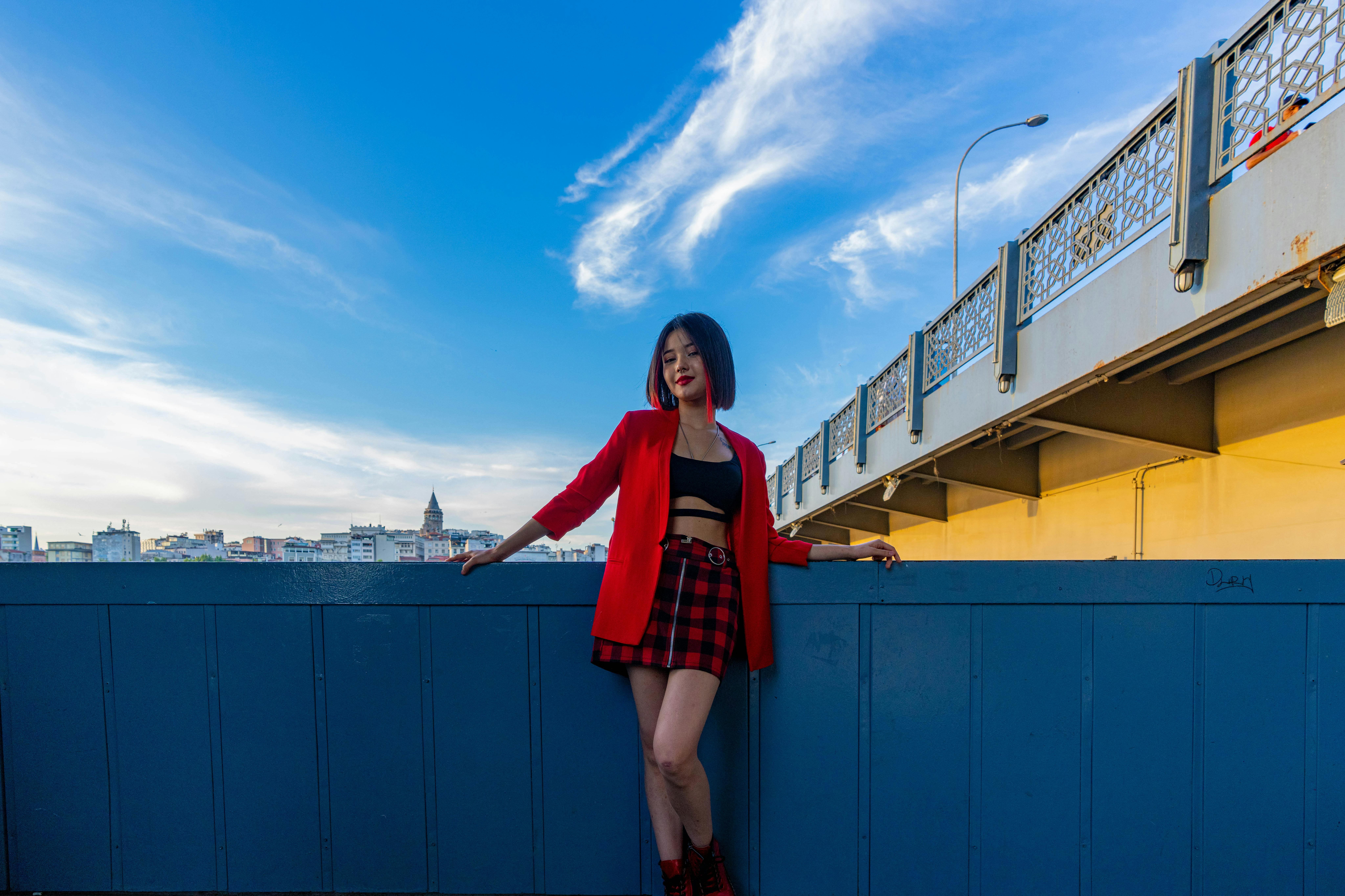 A Stylish Woman Leaning on a Railing · Free Stock Photo