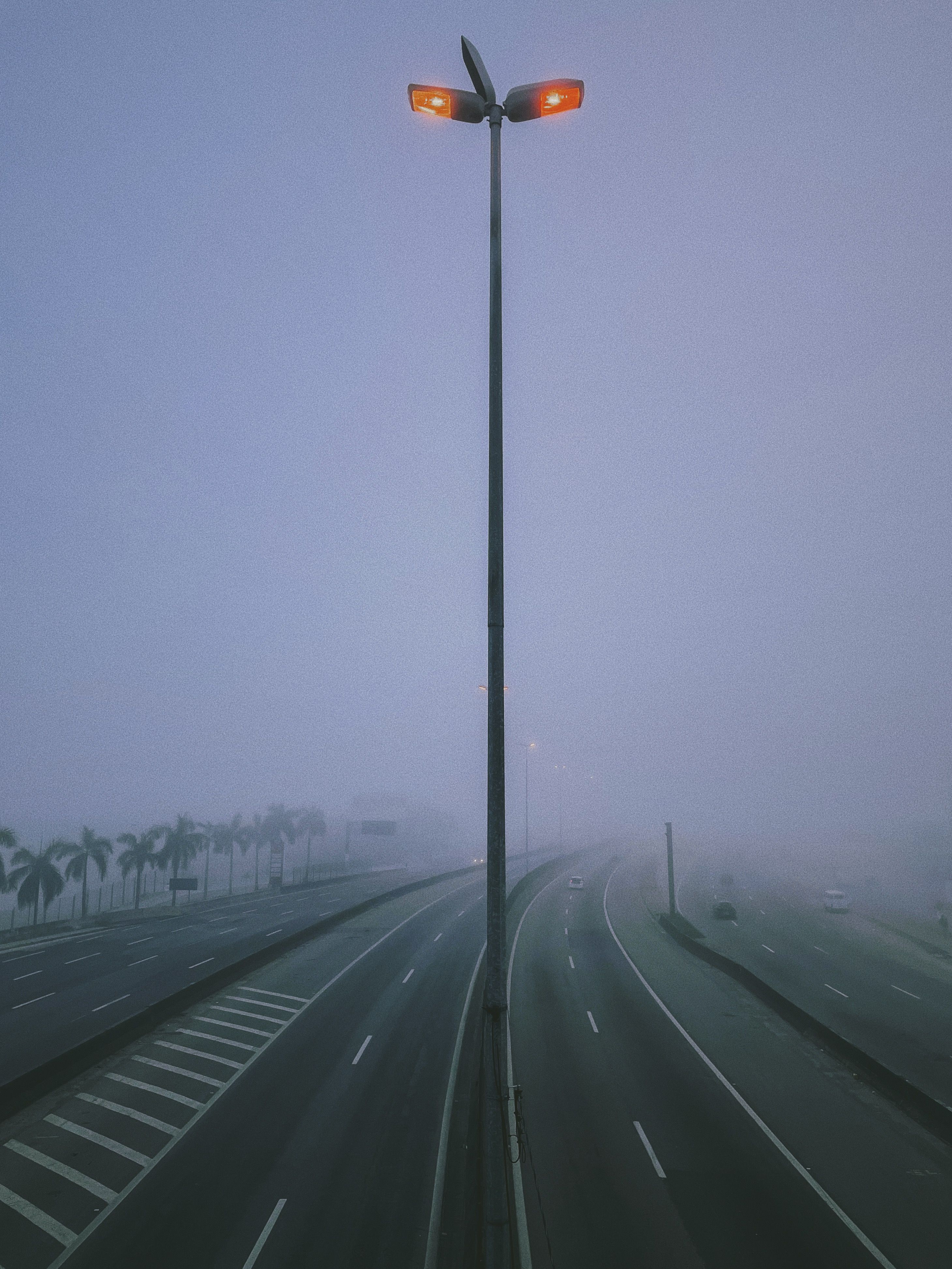 Light Pole Between Highways · Free Stock Photo