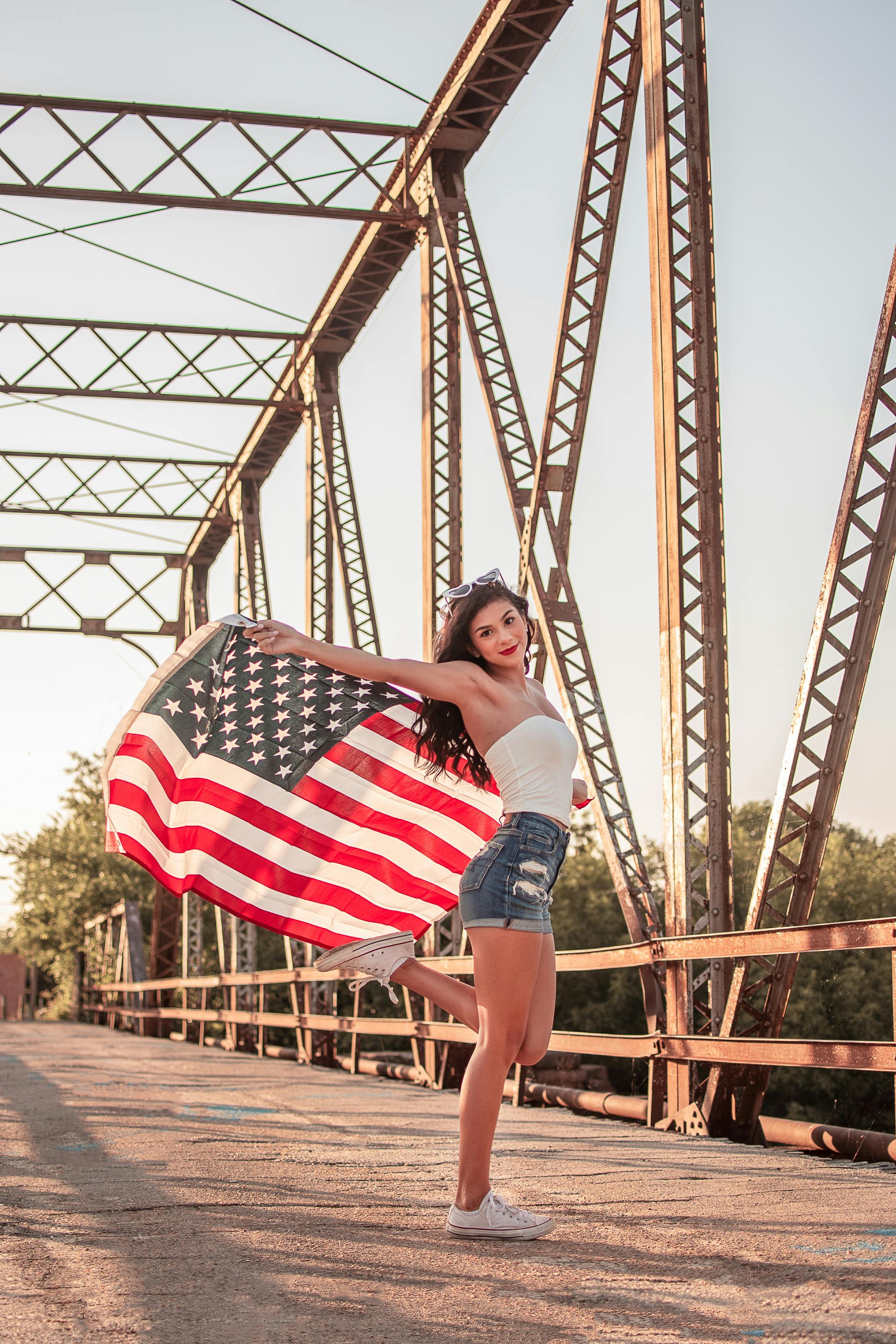 A Woman Holding American Flag · Free Stock Photo