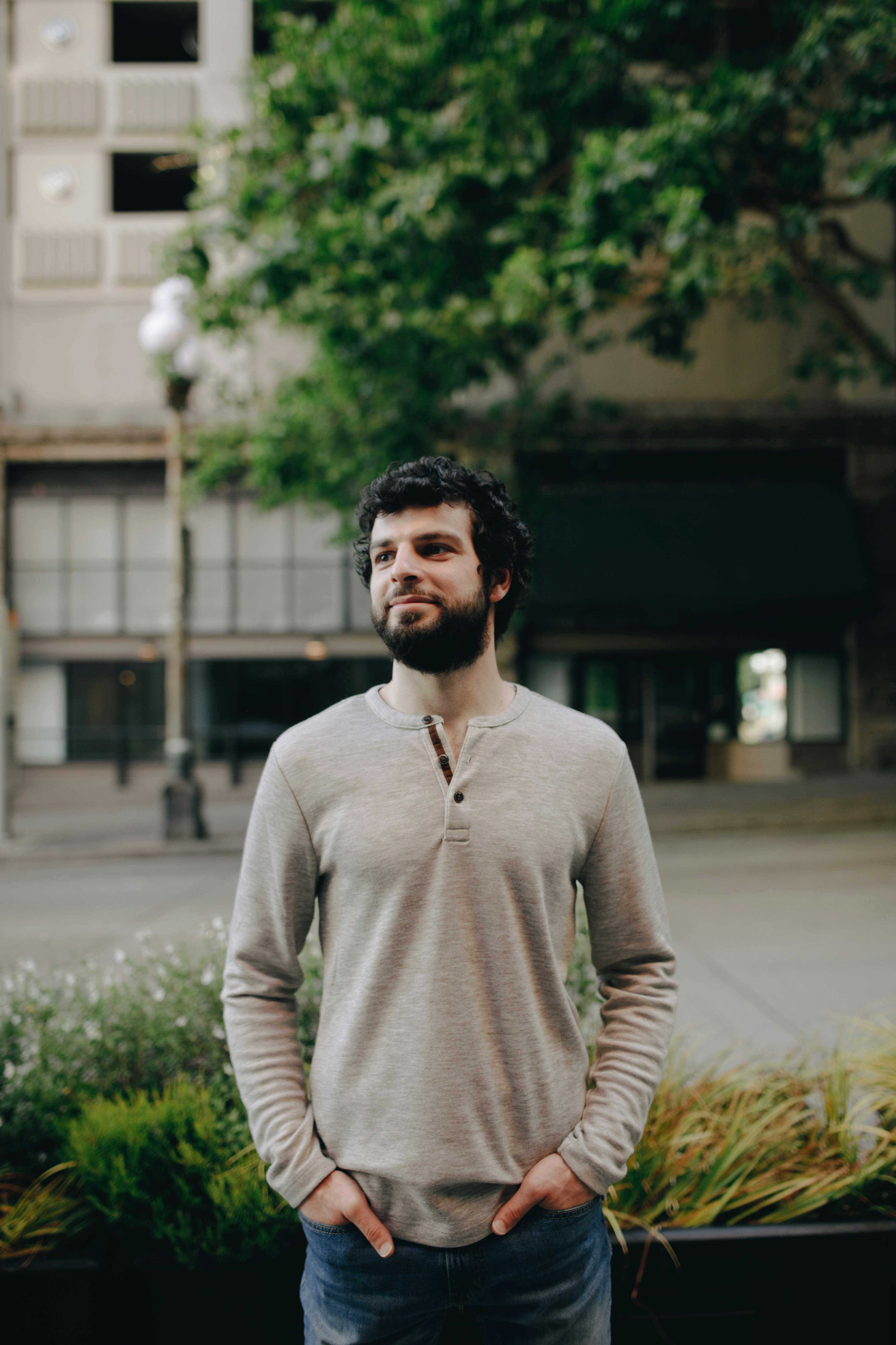 A Bearded Man in Brown Sweater Smiling · Free Stock Photo