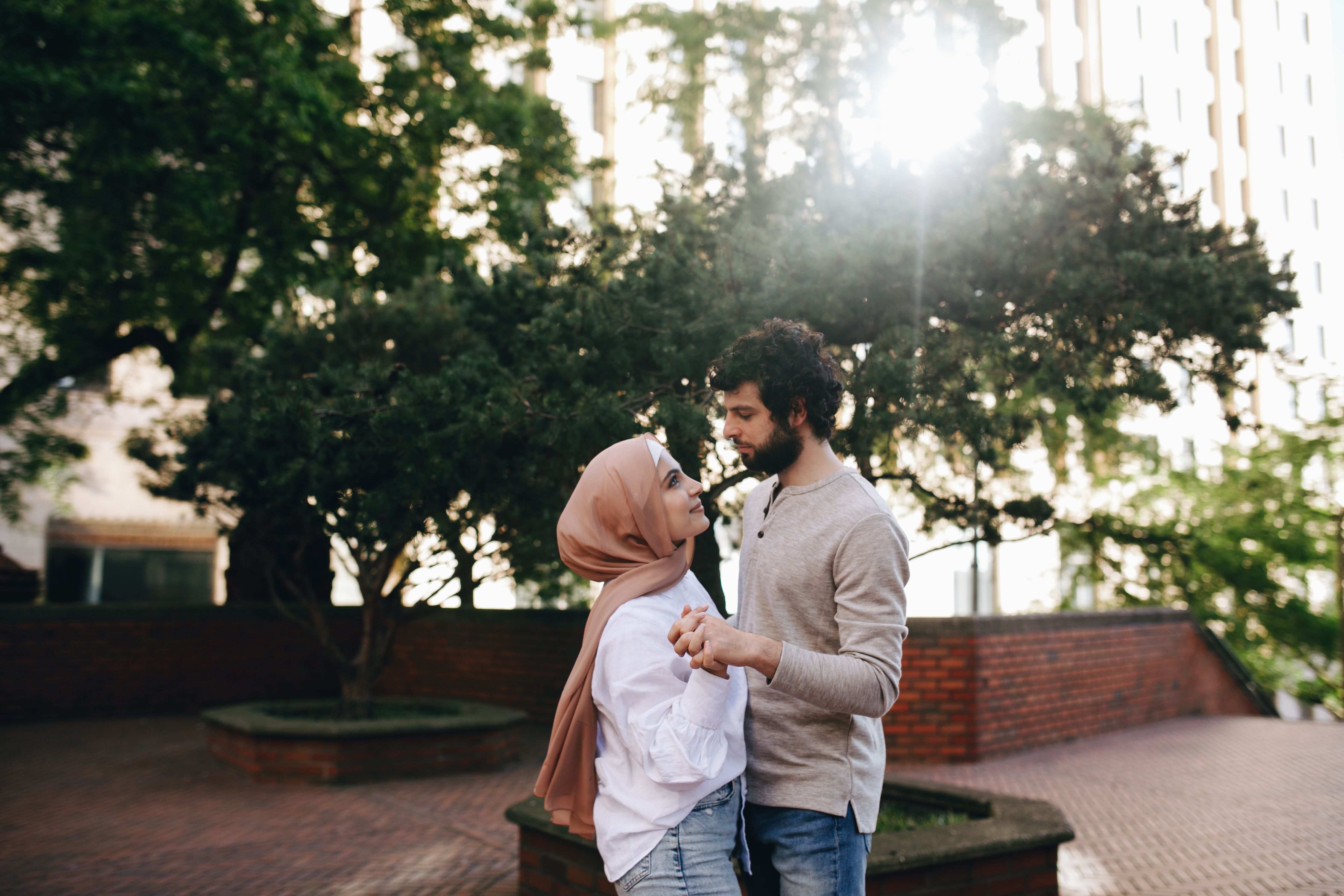 A Romantic Couple Holding Hands and Looking at Each Other · Free Stock ...