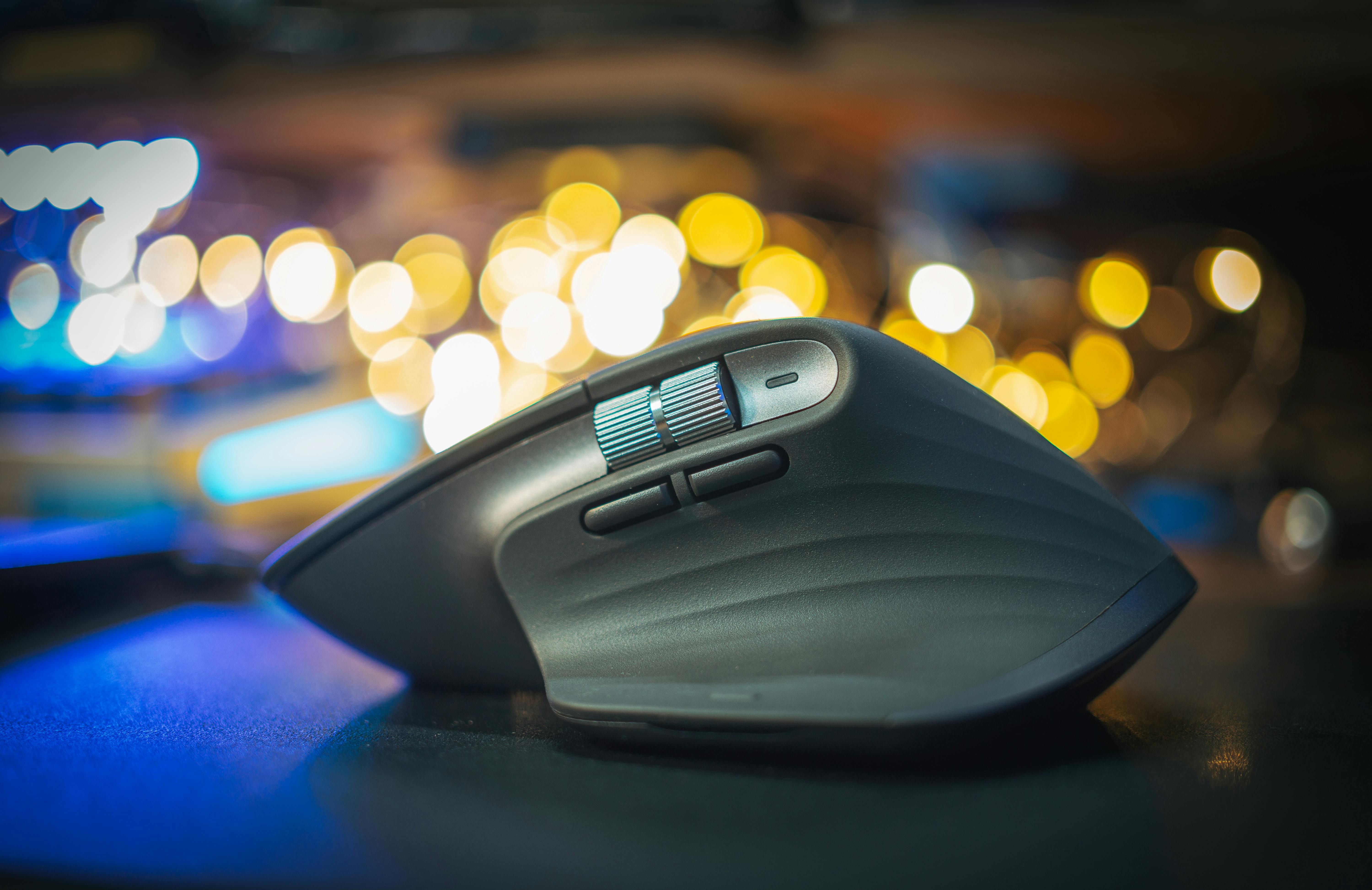 Person Holding Black Cordless Computer Mouse · Free Stock Photo