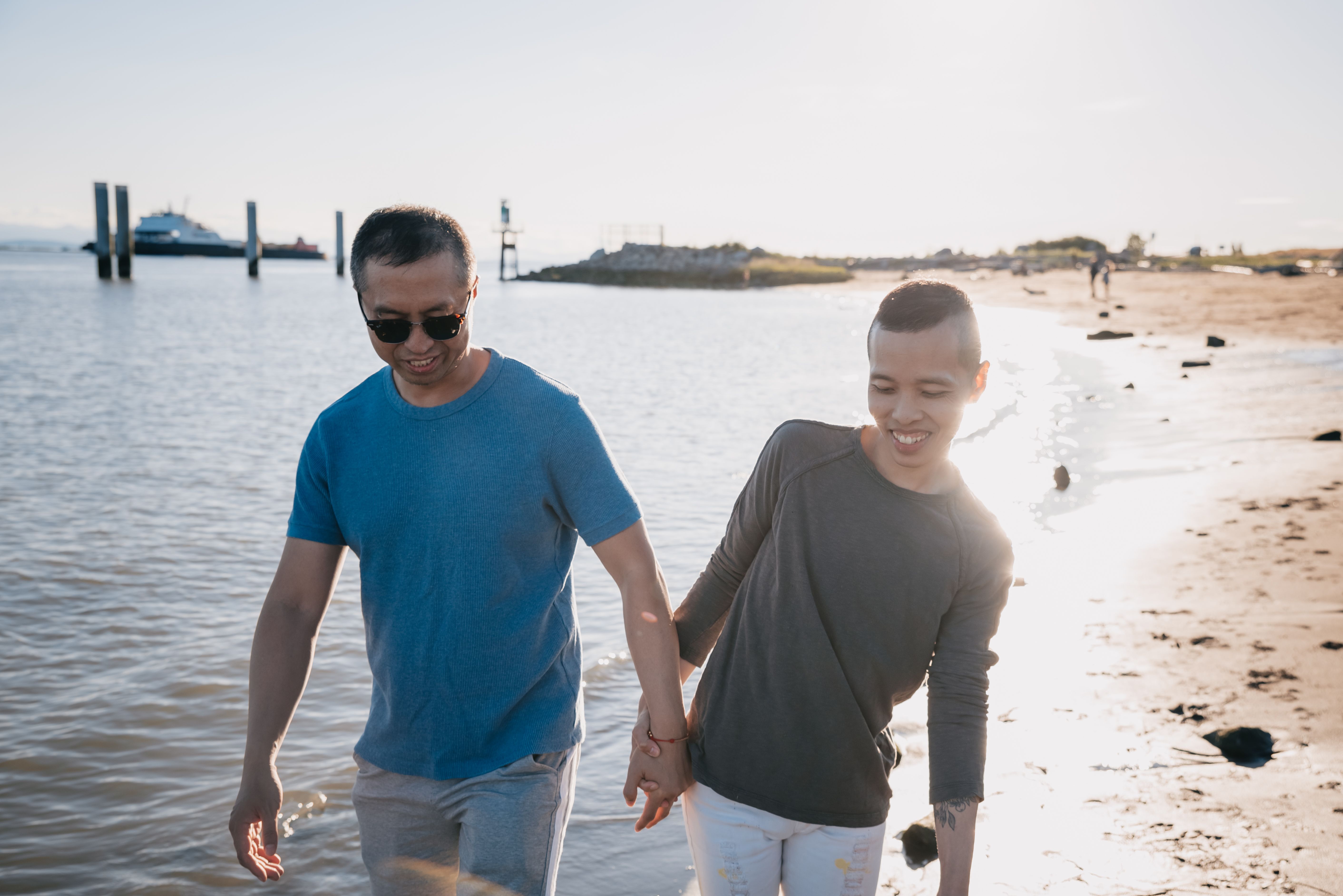 Partly Dressed Pregnant Woman and Man Walking on Beach · Free Stock Photo