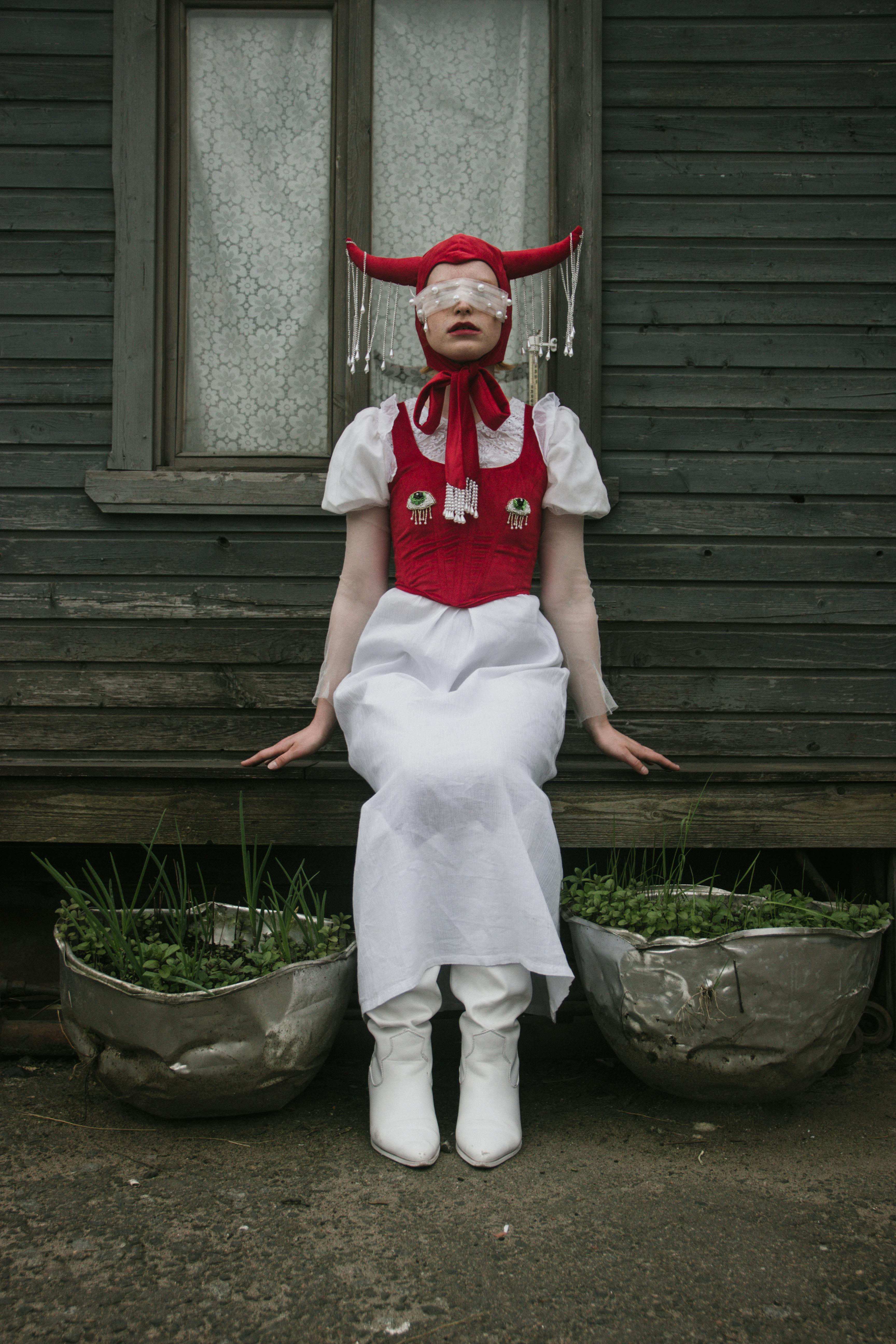 Woman in Eccentric Costume Sitting on Bench near Wooden House · Free ...
