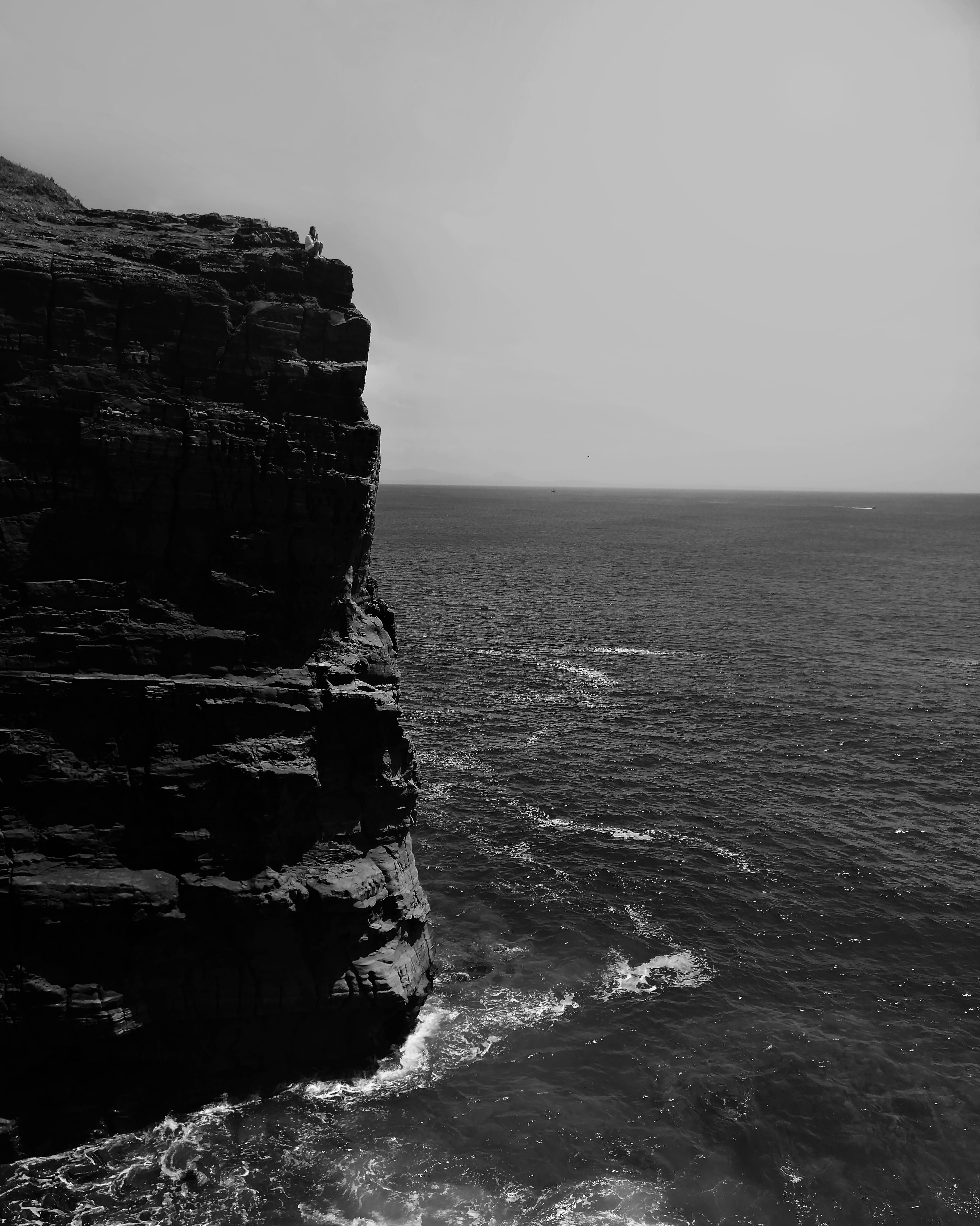 Black and White Photo of a Cliff Near the Sea · Free Stock Photo