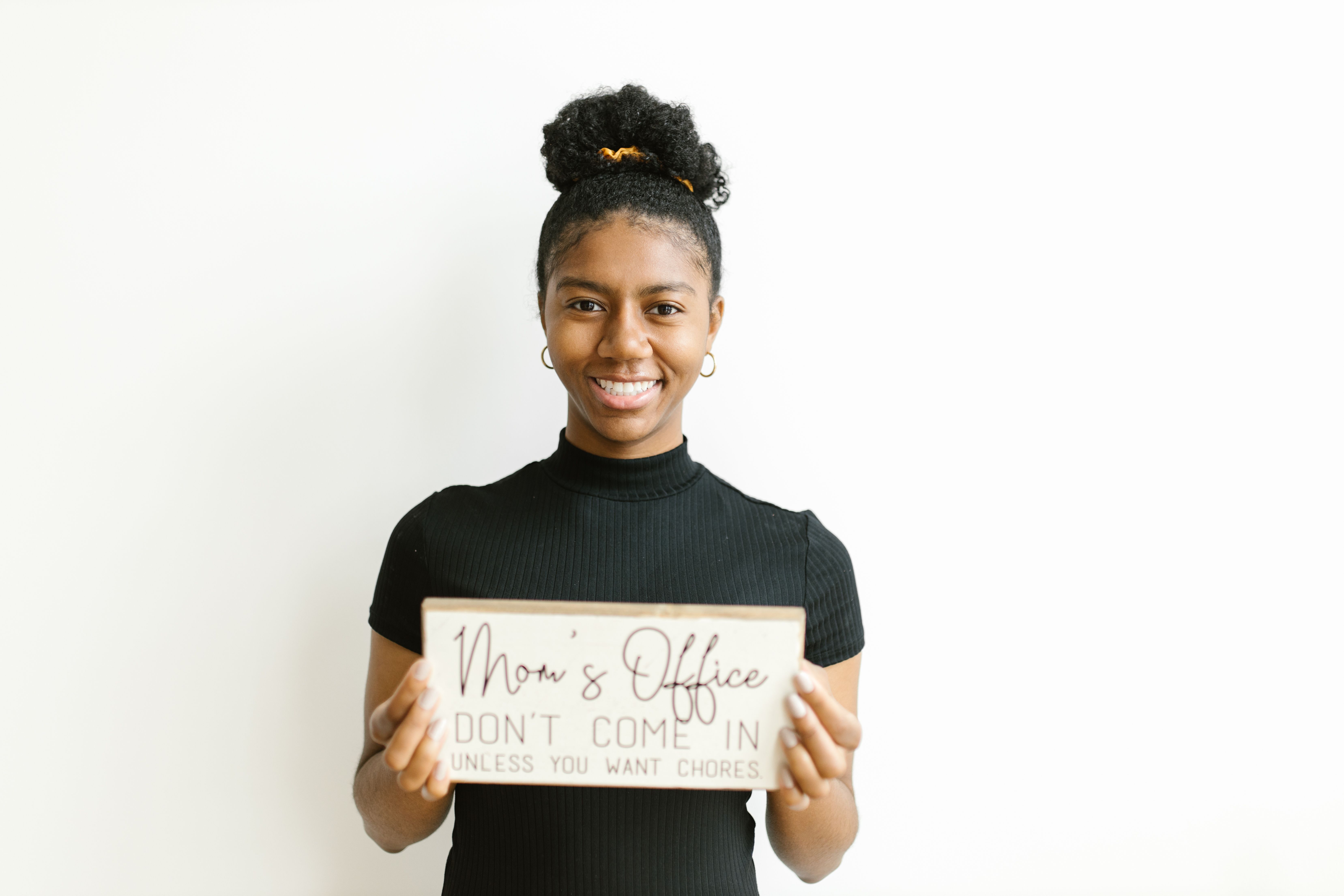 Beautiful Woman holding a Wooden Placard · Free Stock Photo