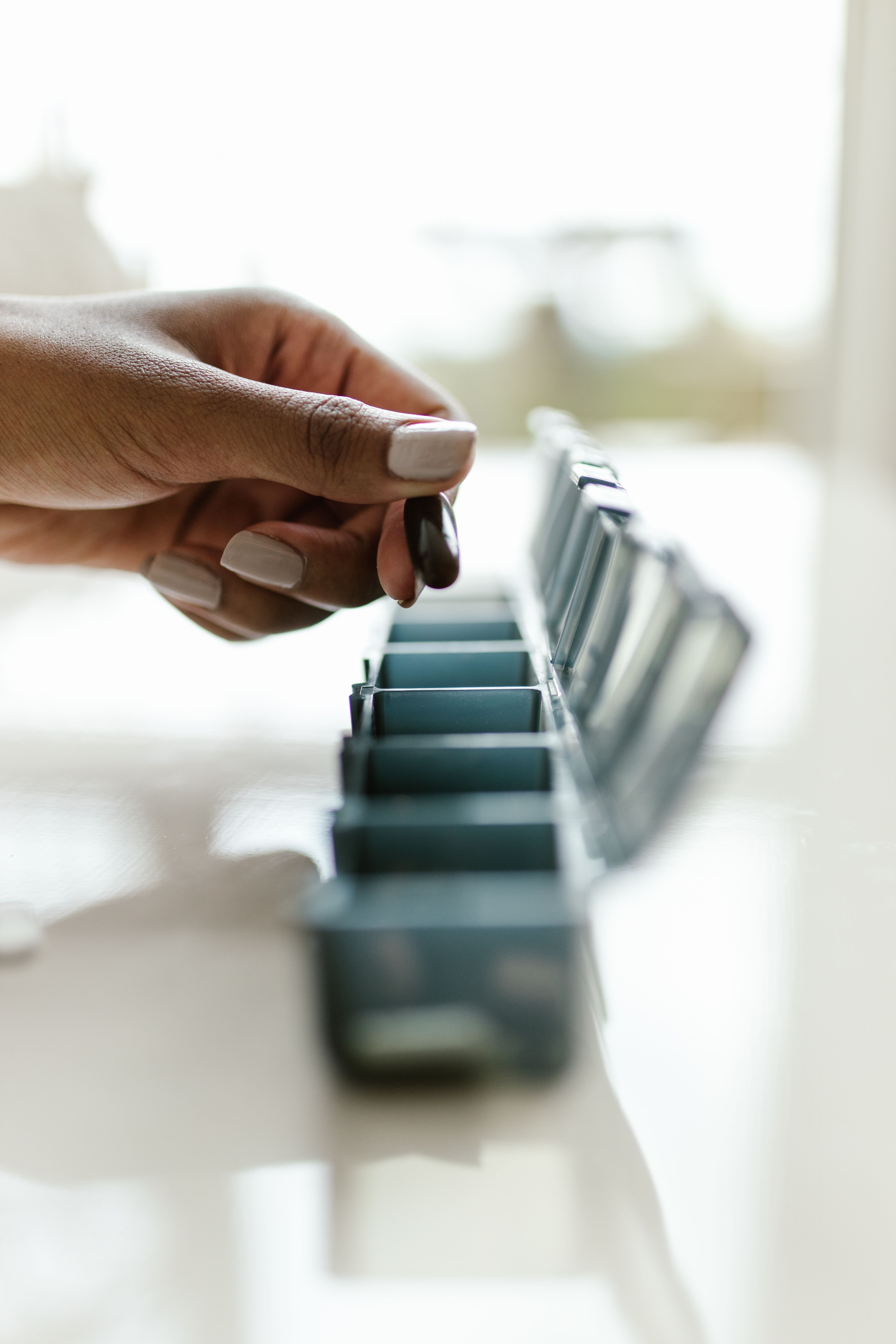 A Close-Up Shot of a Person Taking Medicine from a Bottle · Free Stock ...
