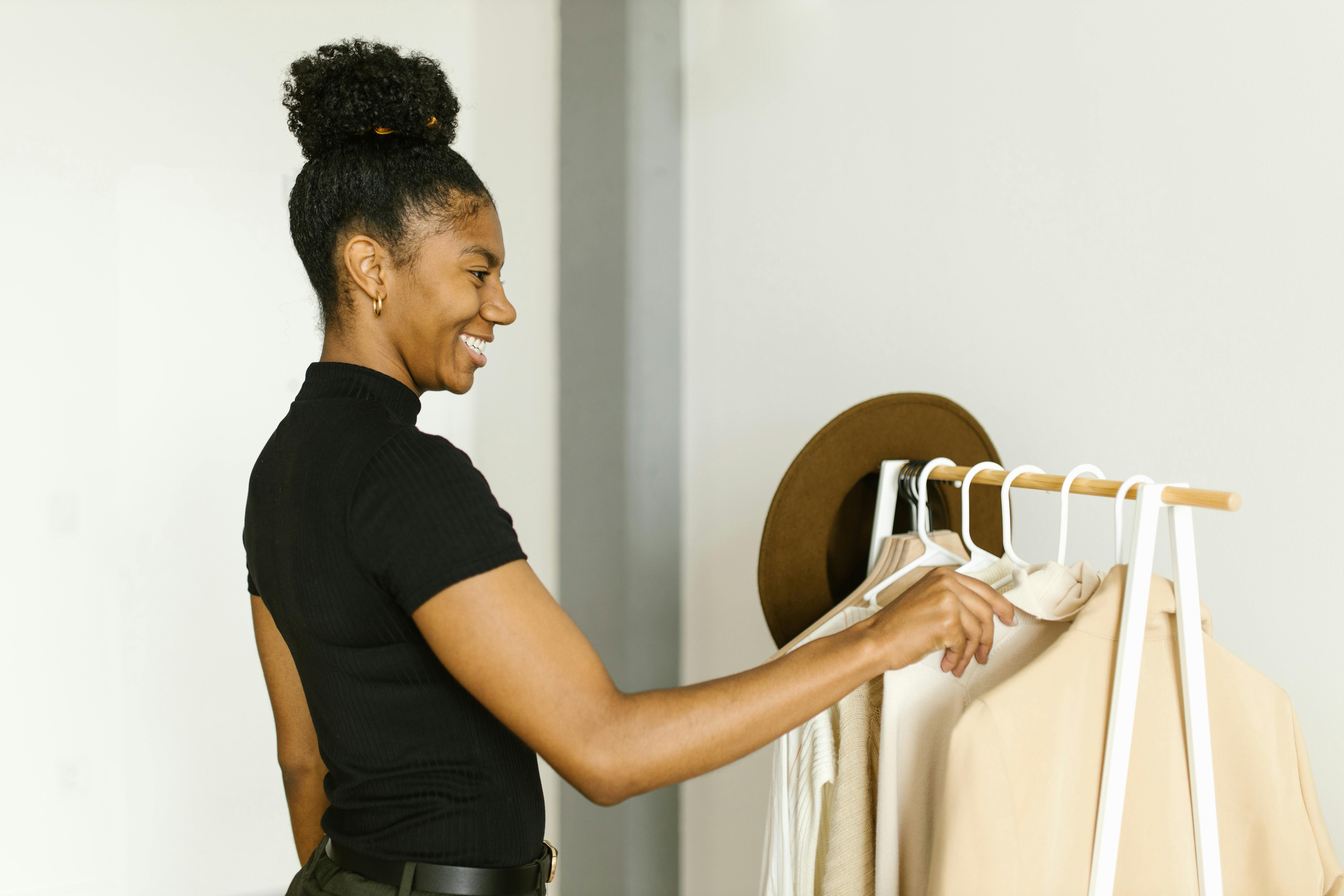 A Woman Looking at Clothes on Rack · Free Stock Photo