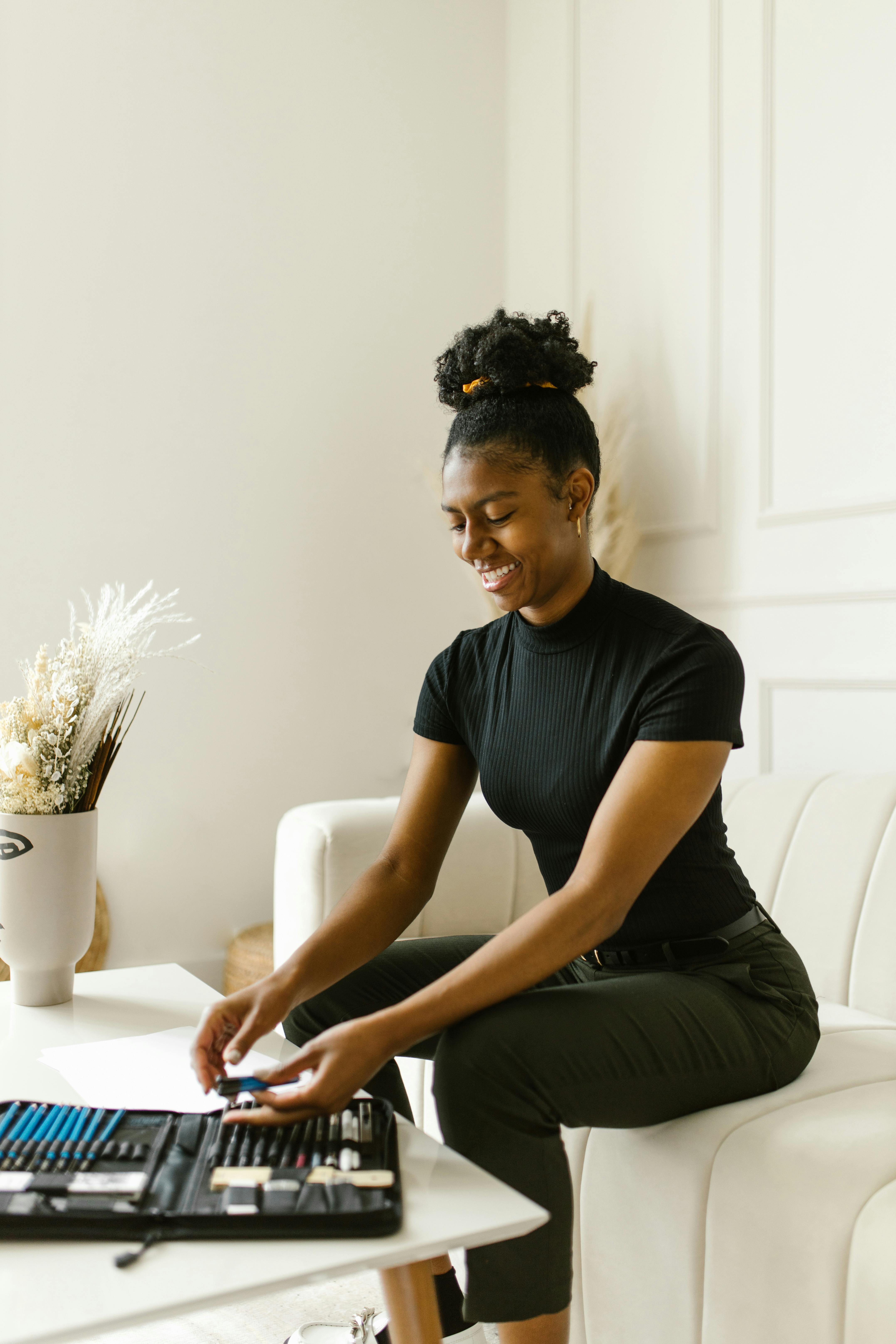 A Woman Arranging Drawing Pencils in its Case · Free Stock Photo