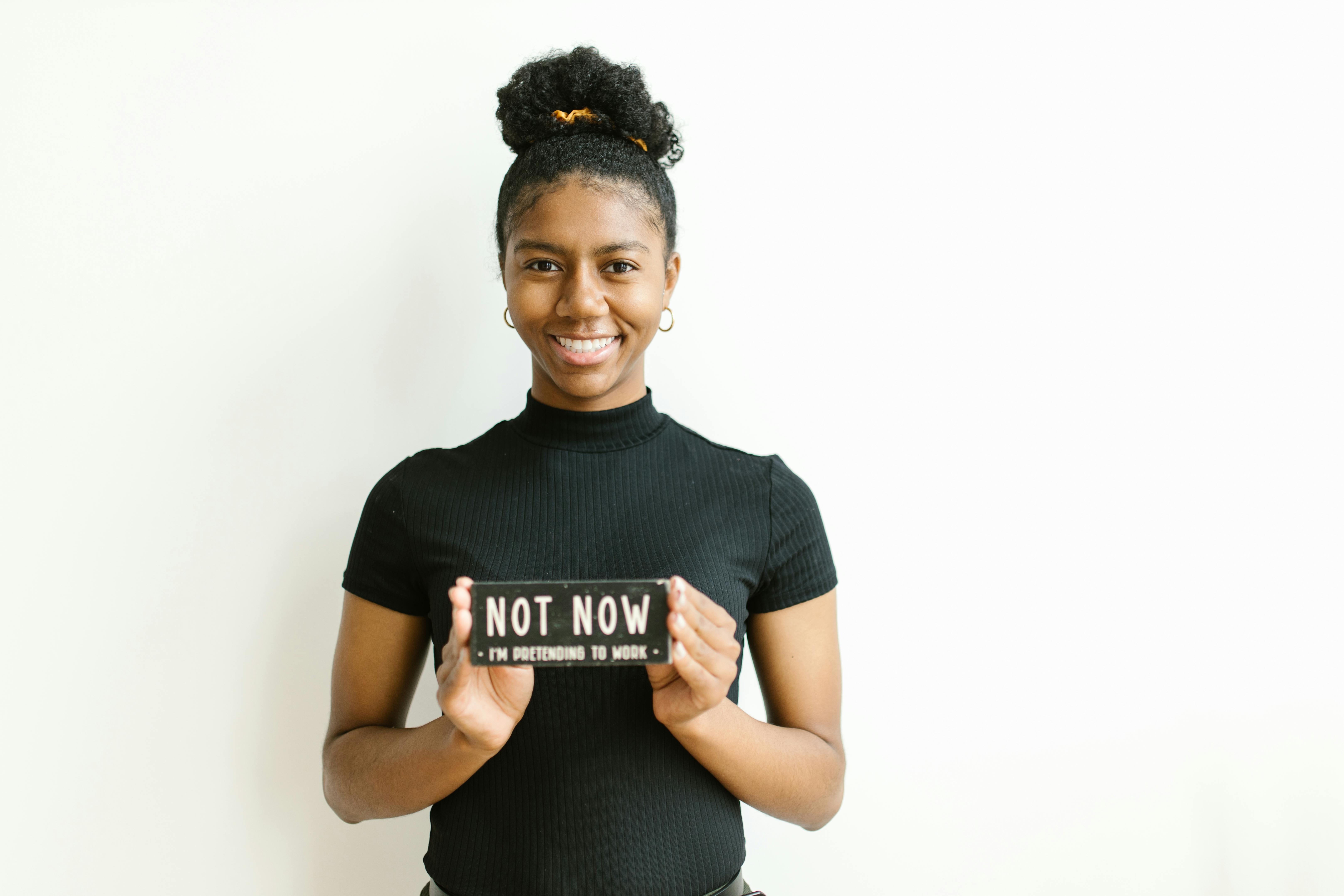Hand of a Woman Holding a Signage · Free Stock Photo