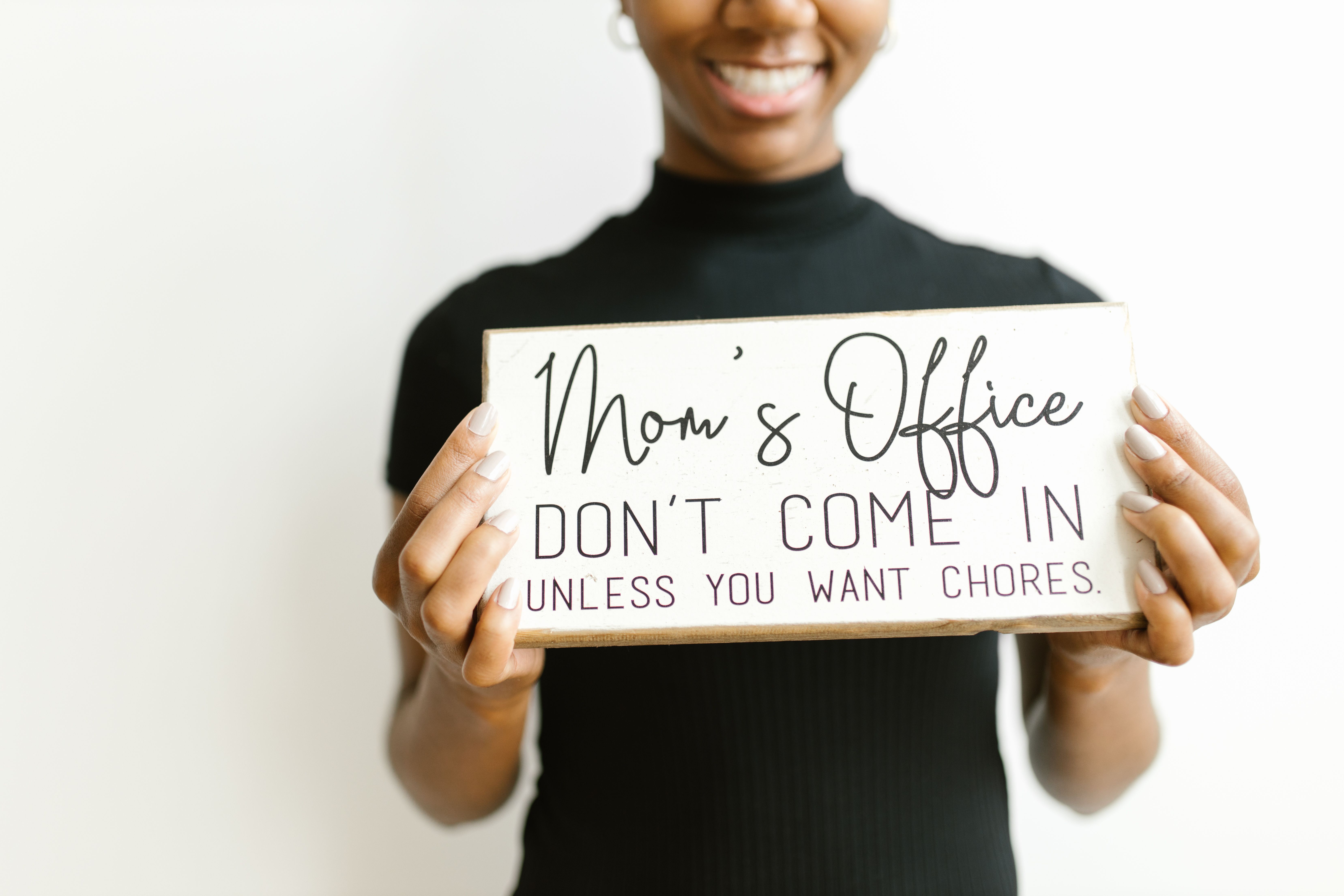 A Person Holding a Hanging Signage · Free Stock Photo