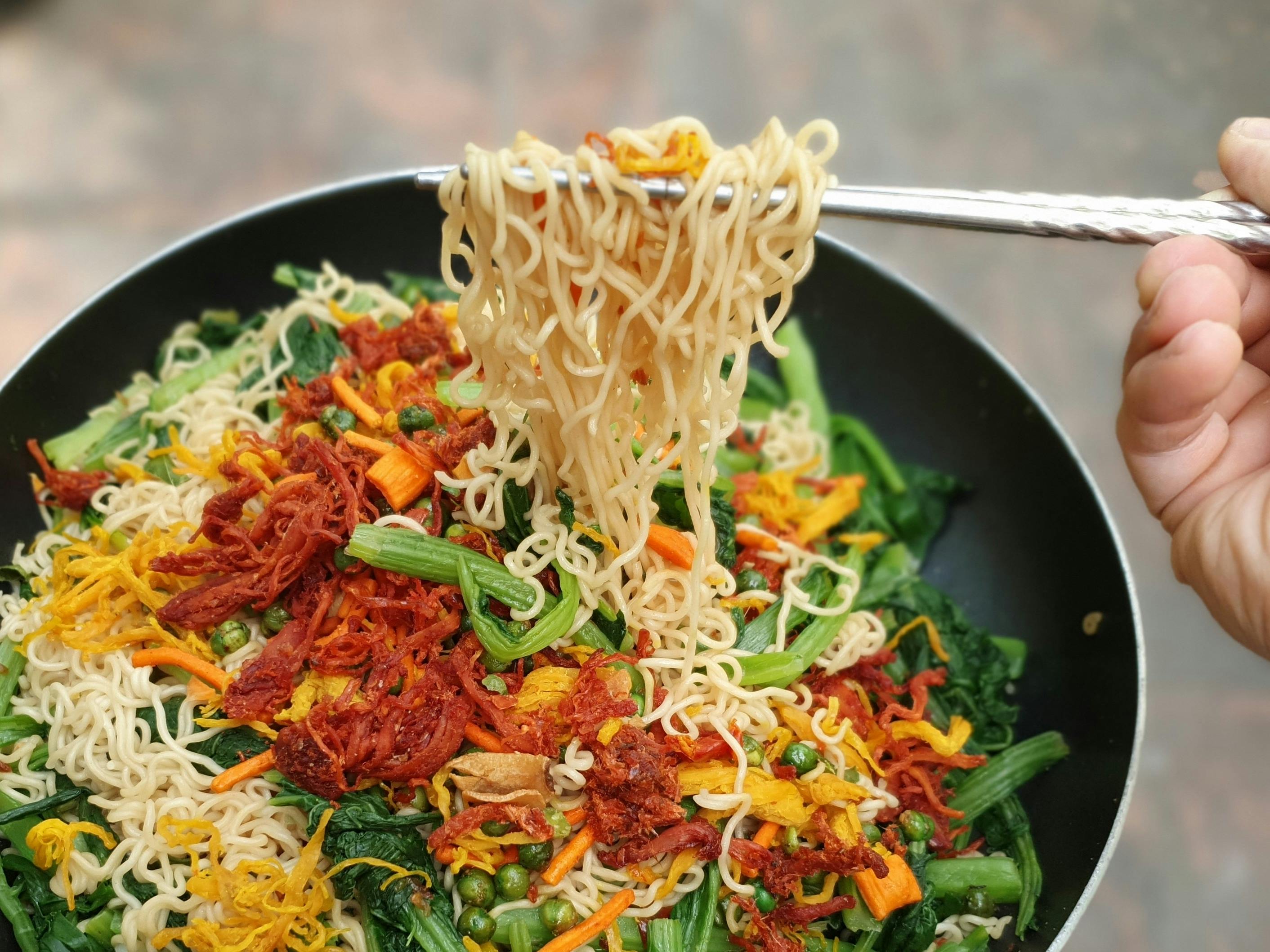 Person Hand Eating Noodles with Chopsticks · Free Stock Photo