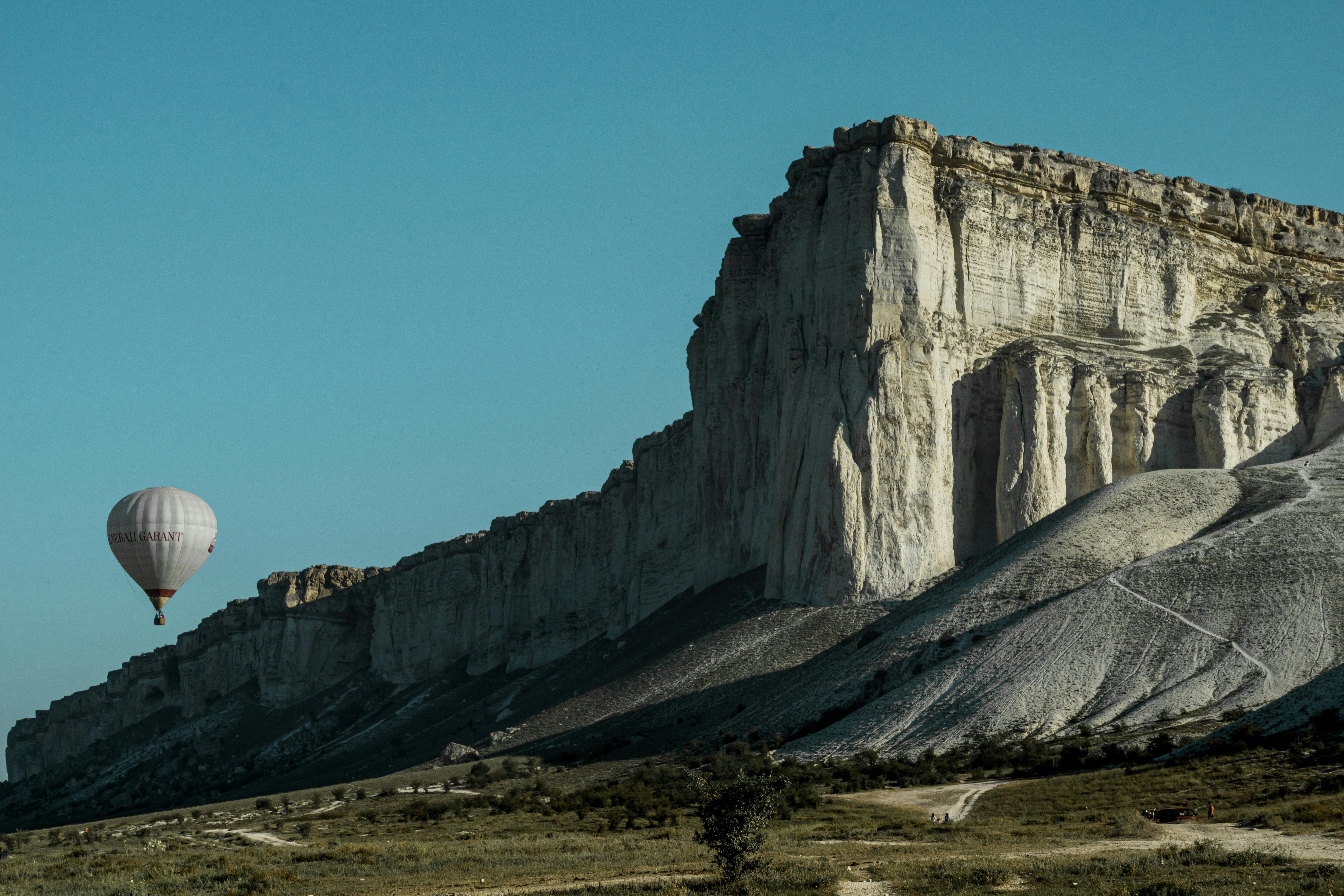 Rock Formation and Hot Air Balloon against Blue Sky · Free Stock Photo