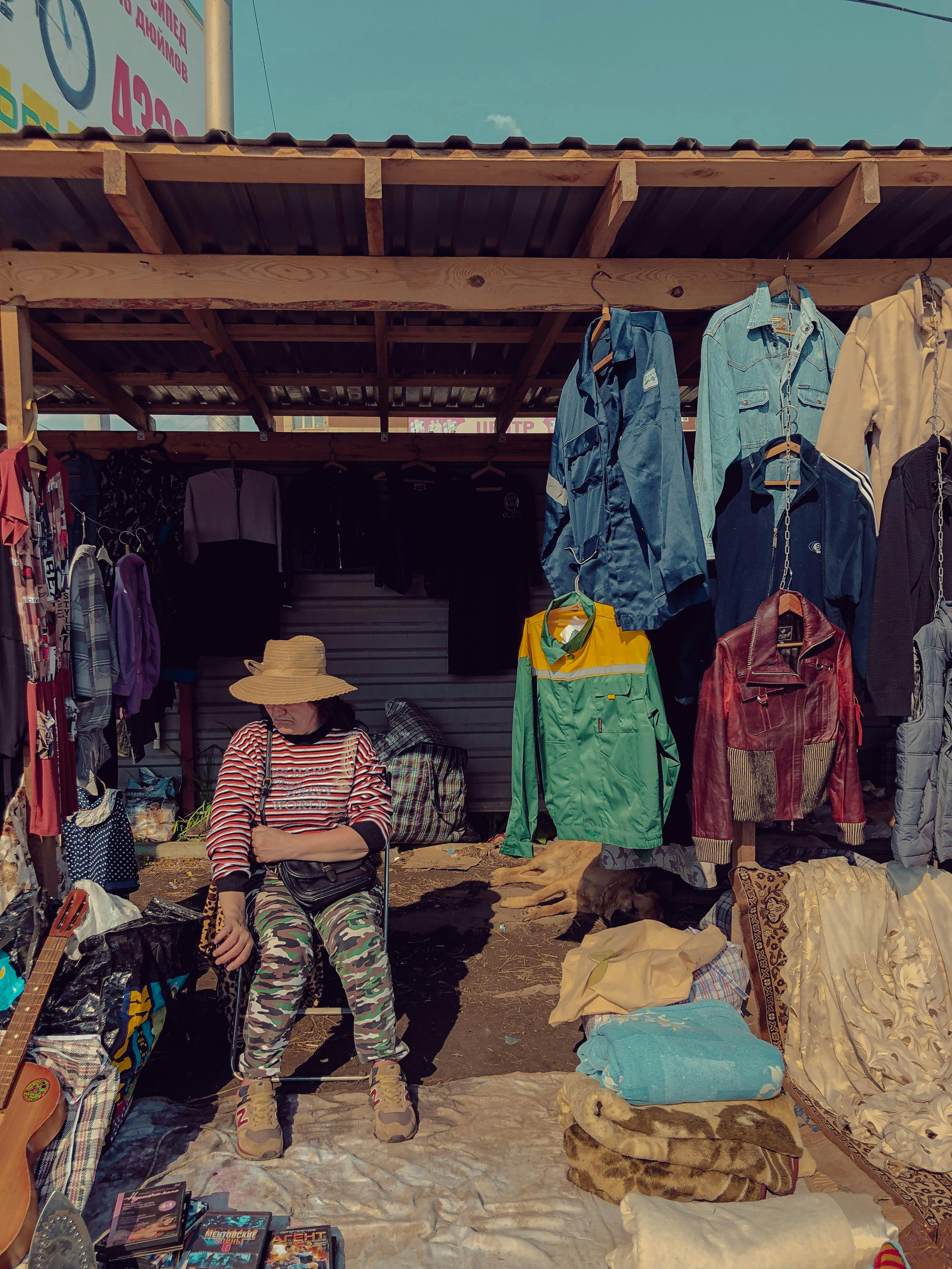 Woman Selling Clothes on a Market · Free Stock Photo