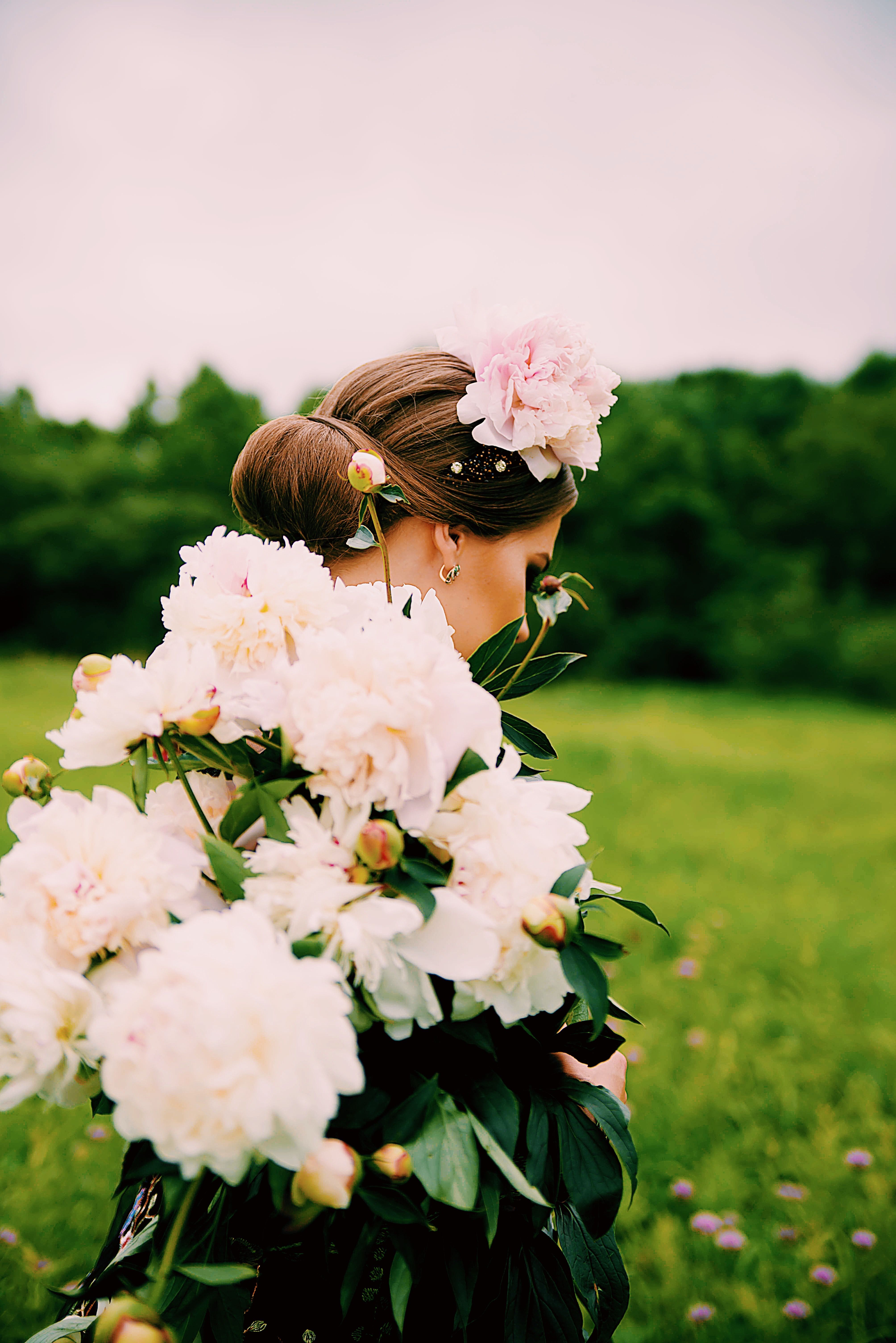 A Woman Behind the Plant with White Flowers · Free Stock Photo
