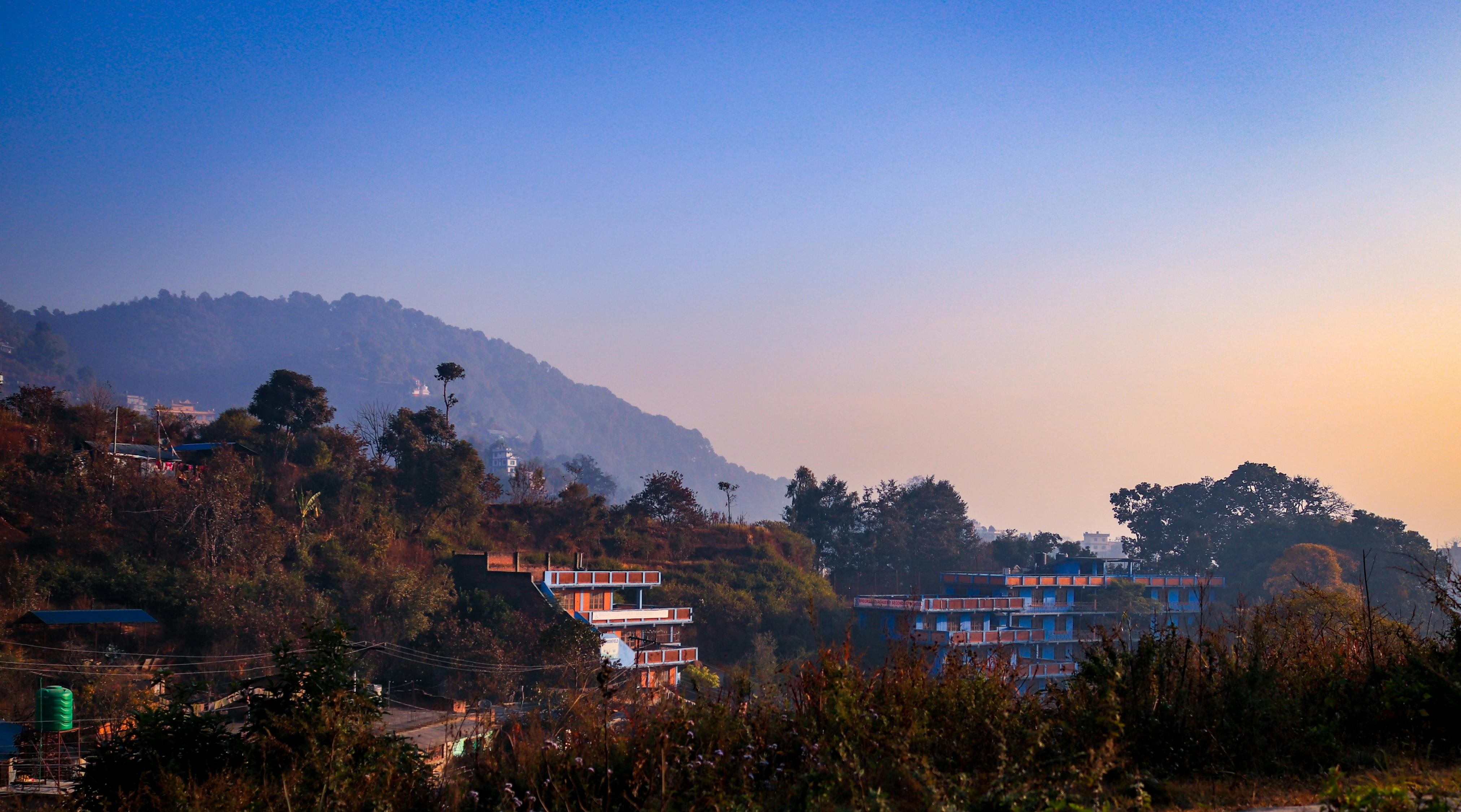 Sunset above Houses on Hills in Mountain Landscape · Free Stock Photo