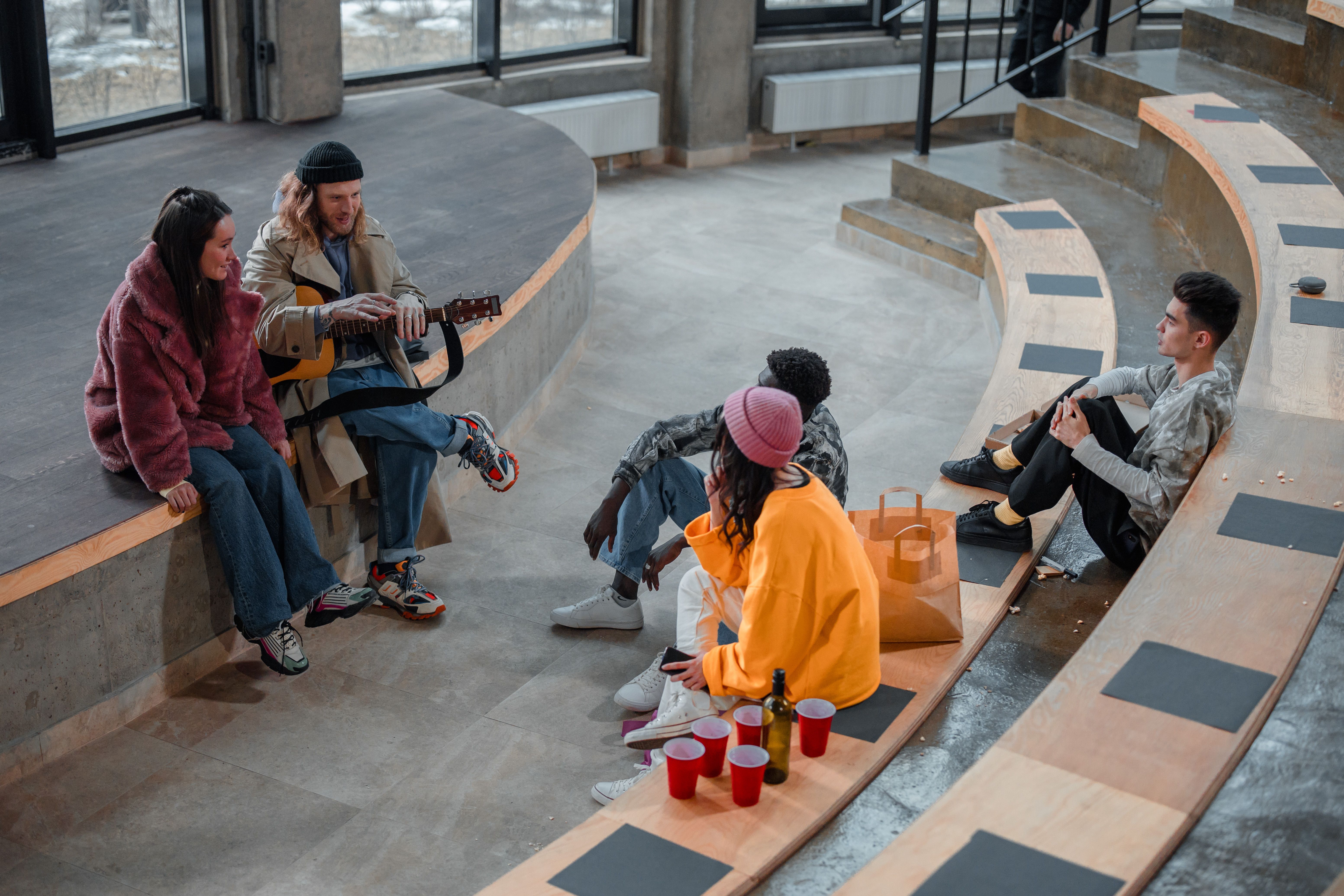Friends Sitting in Amphitheatre · Free Stock Photo