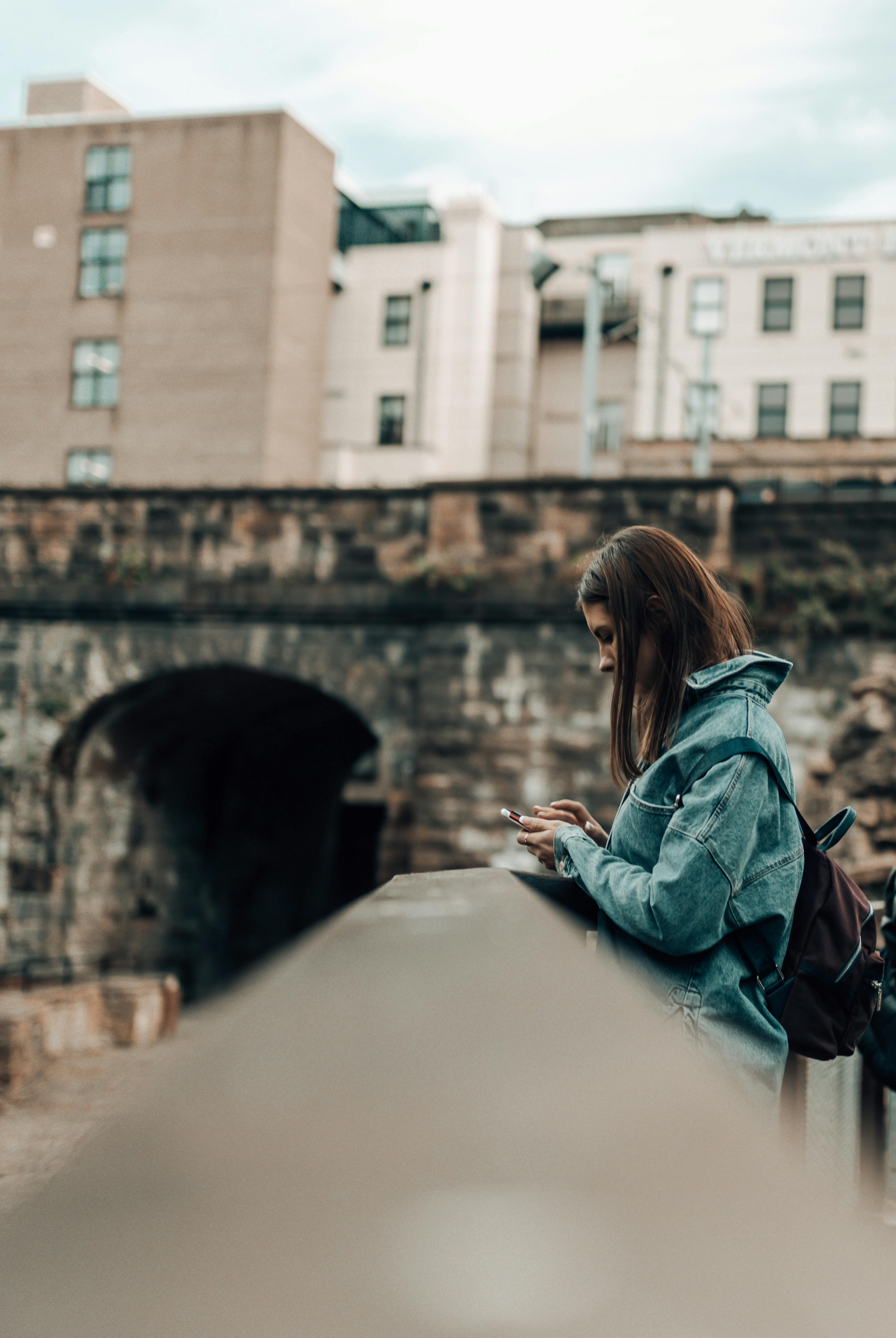 Person Looking Over the Concrete Railing · Free Stock Photo