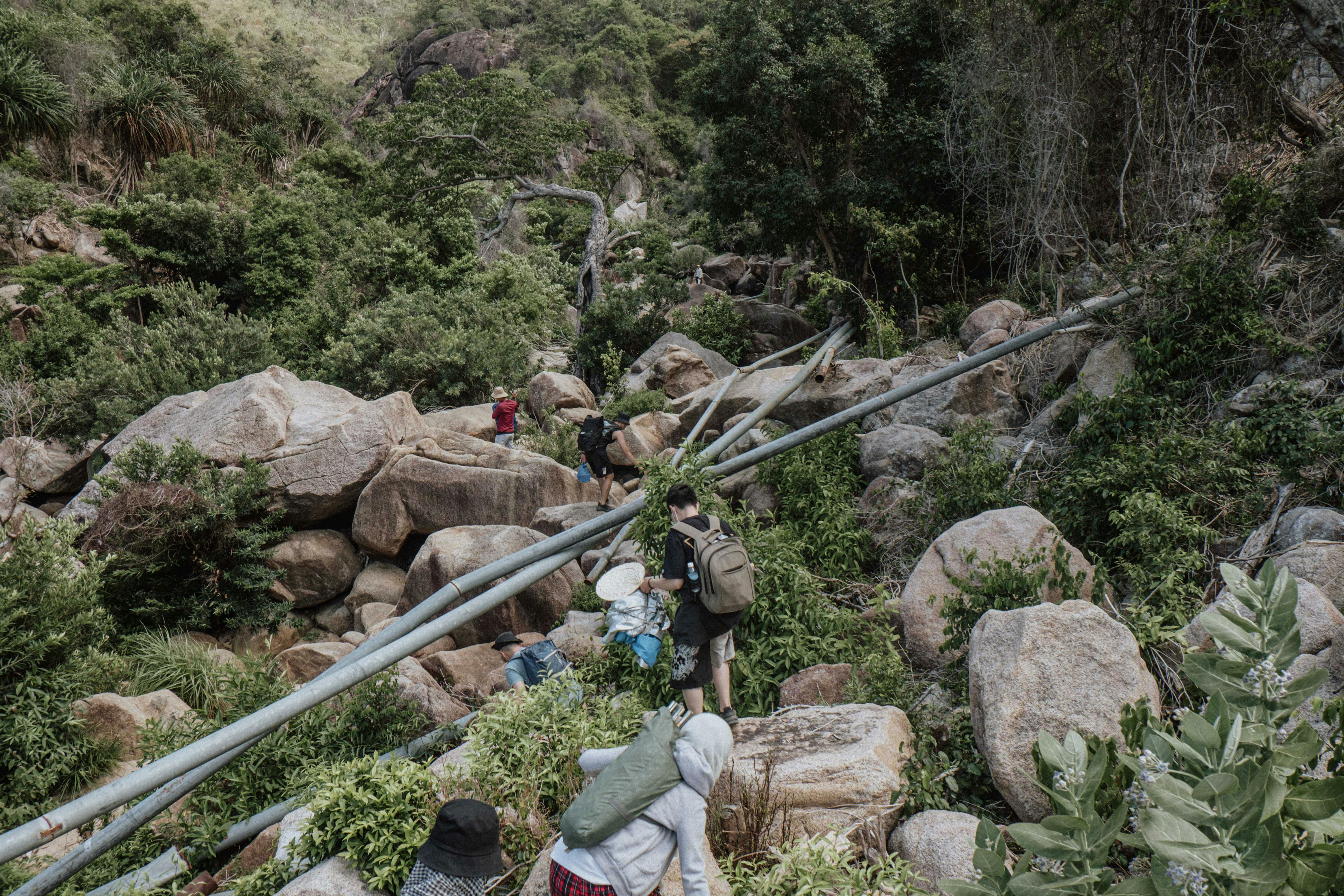 Group of People Hiking Through the Rocks · Free Stock Photo
