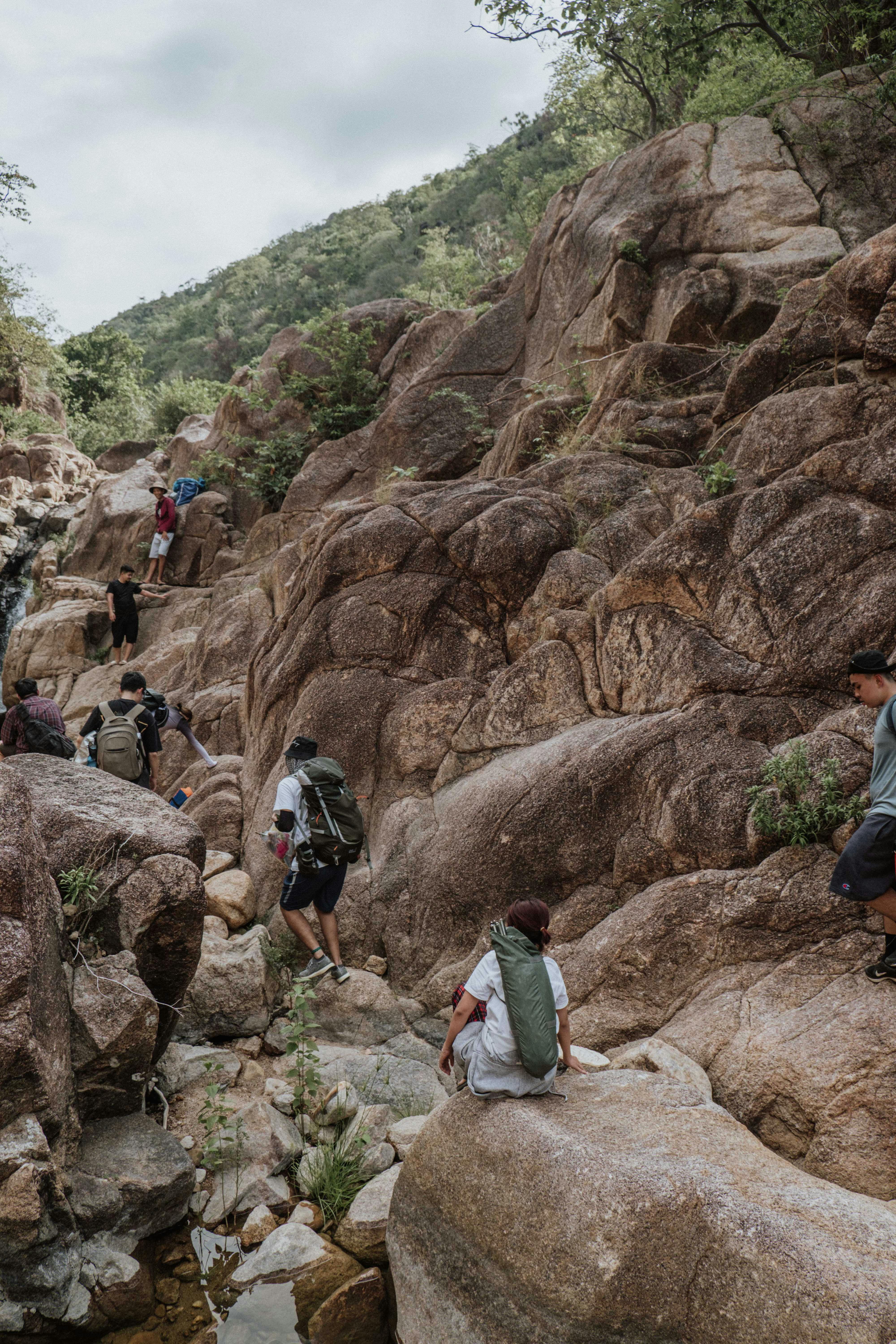 People Hiking Through Rocky Trail in Mountains · Free Stock Photo